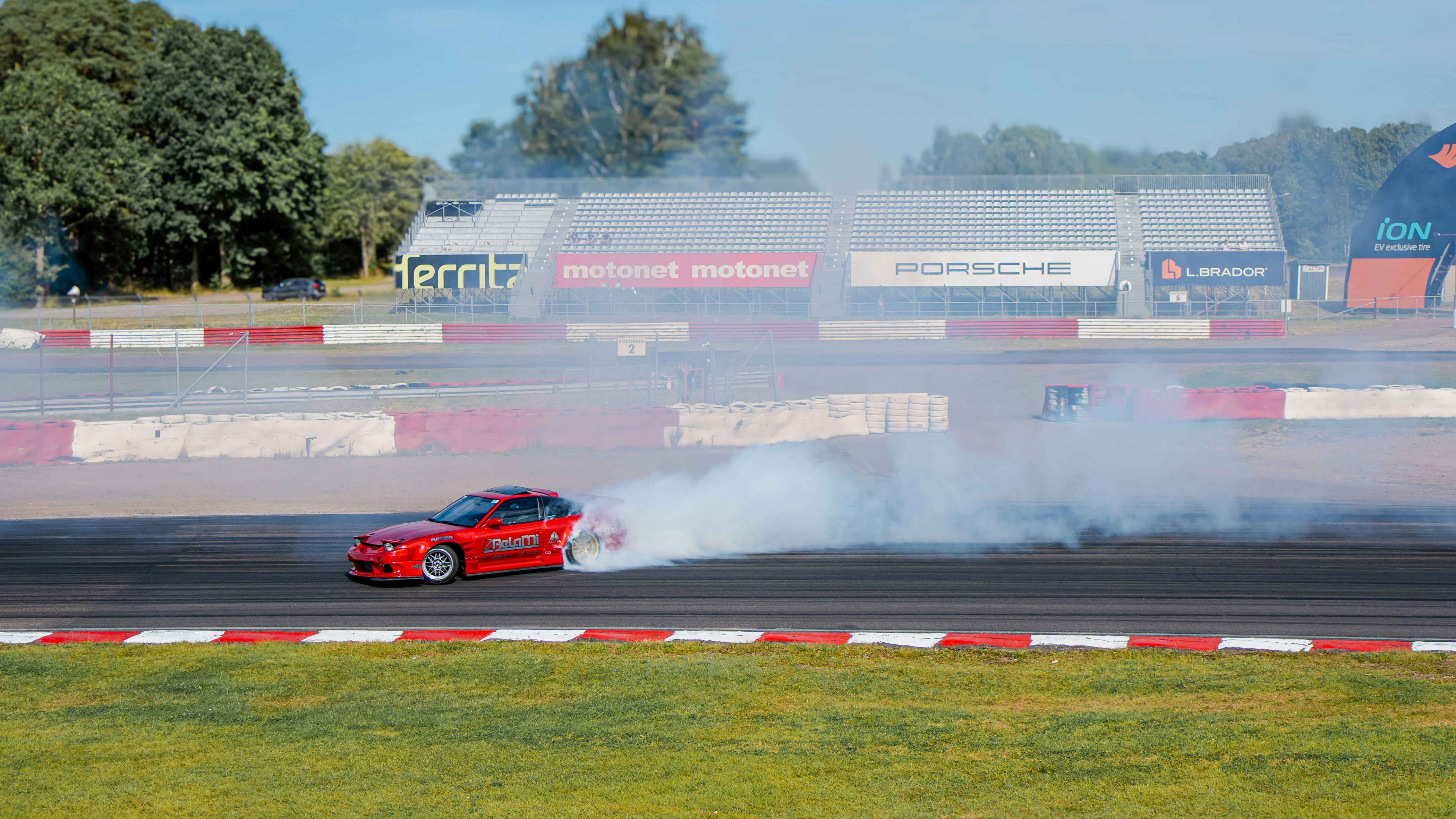 Red Drift at the Raceway: A Blaze of Smoke and Speed