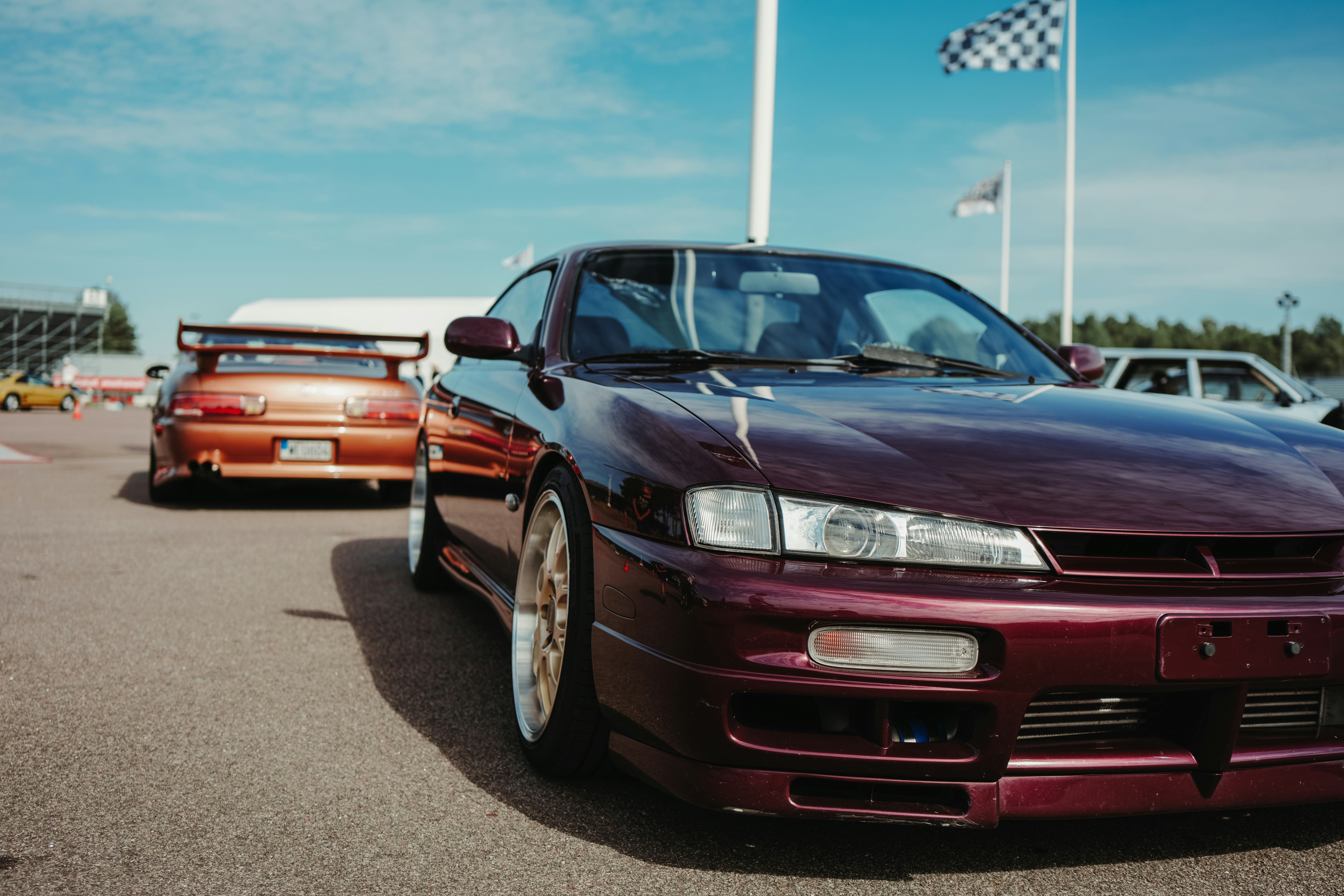 Maroon Japanese Drifter: A Low-Angle Close on a Front Bumper