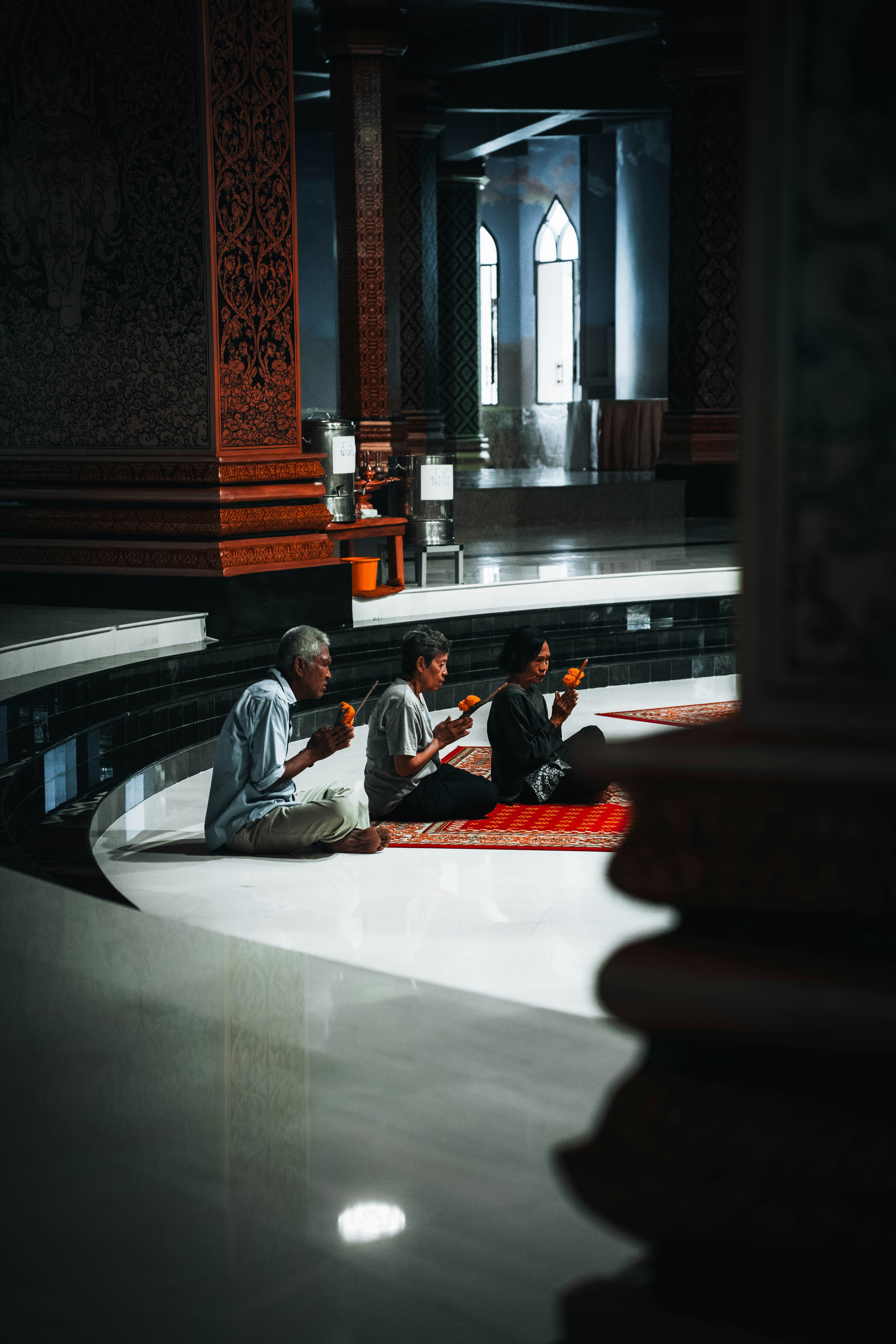 Quiet Prayer: Three Worshipers in a Painted Mosque Hall