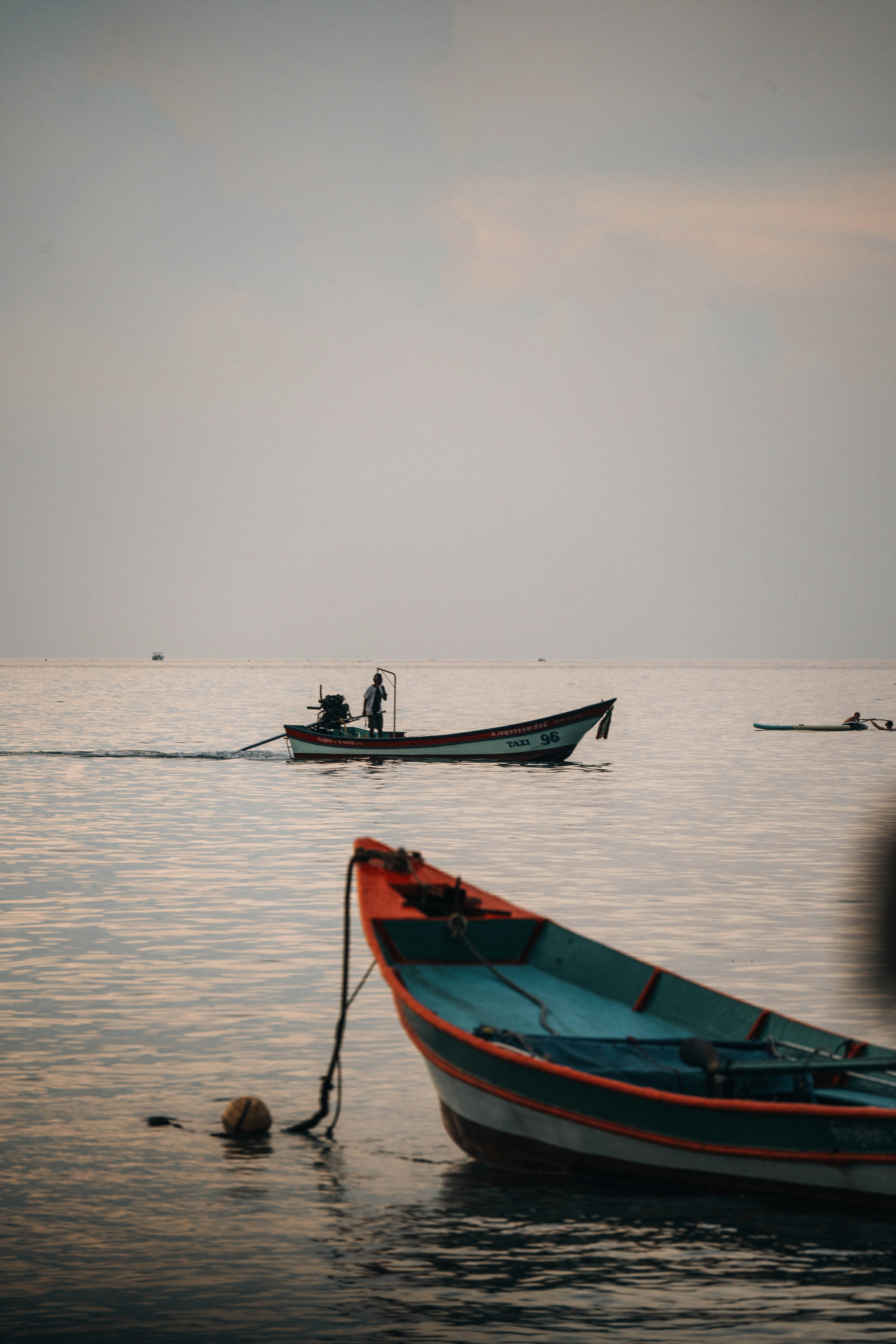 Quiet Horizon: A Trio of Boats Draped in Dusk