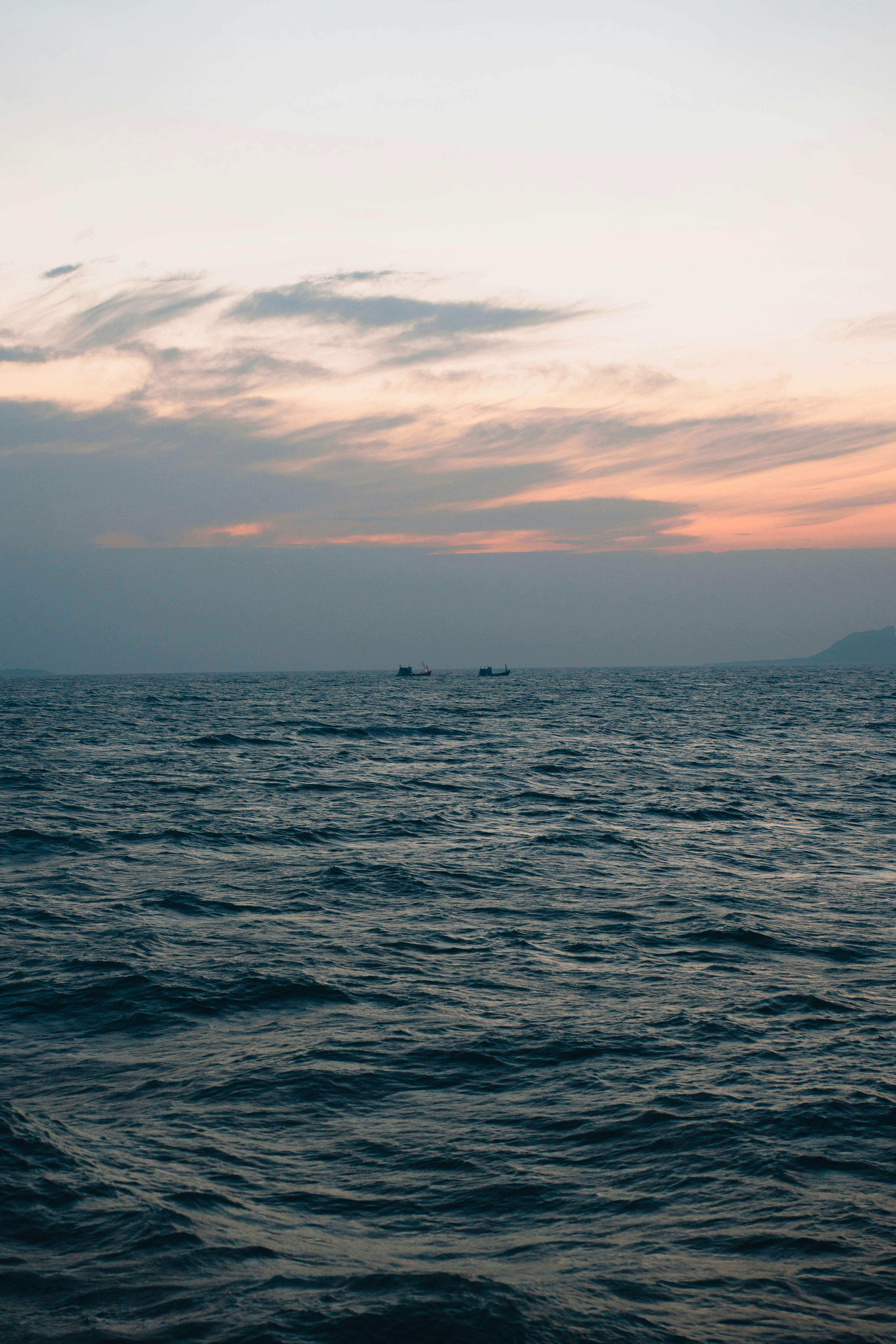 Horizon Quiet: Boats Dot the Calm Atlantic at Sunset