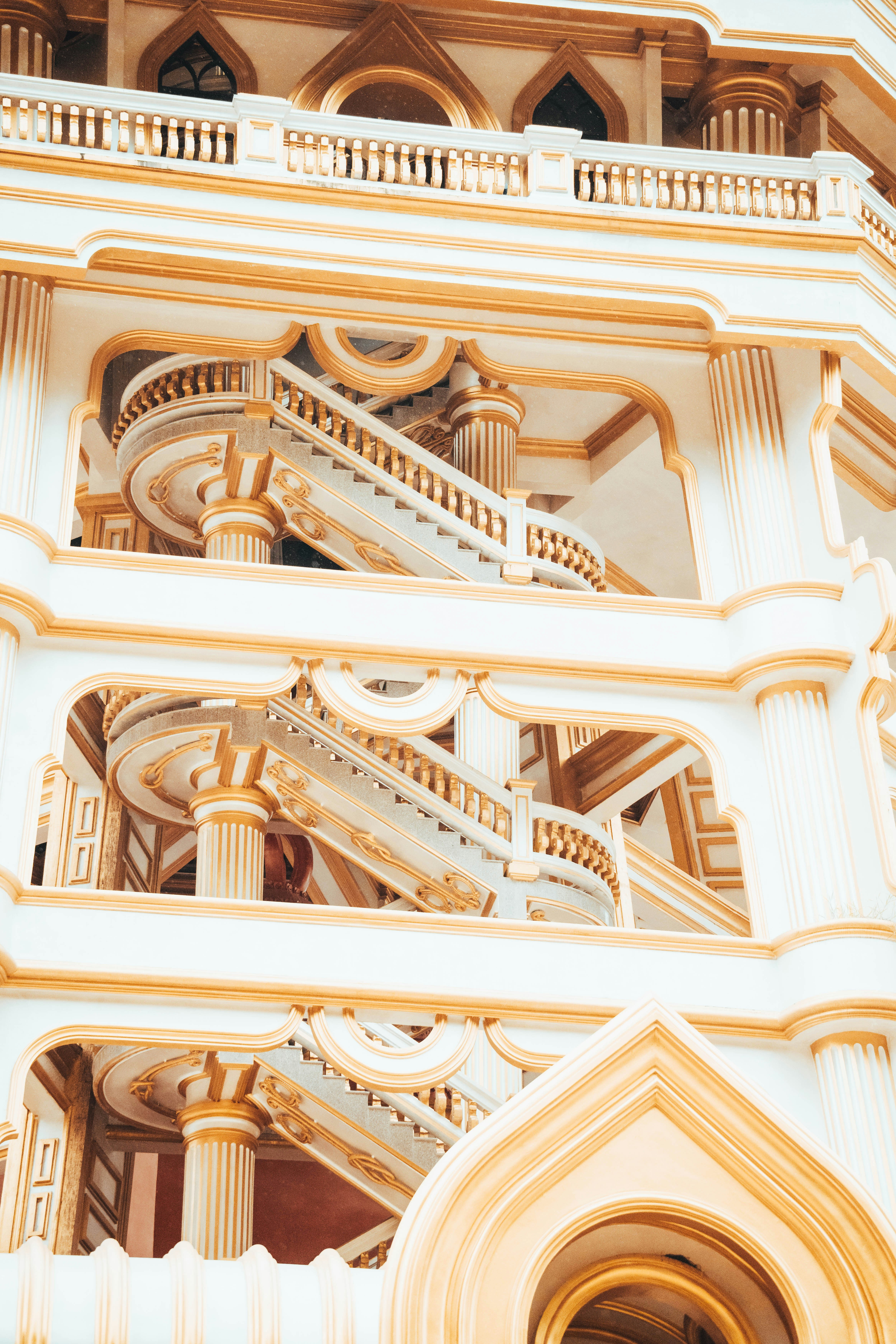 Ornate Staircase Gallery: Sunlit Carved Carvings and Pillars