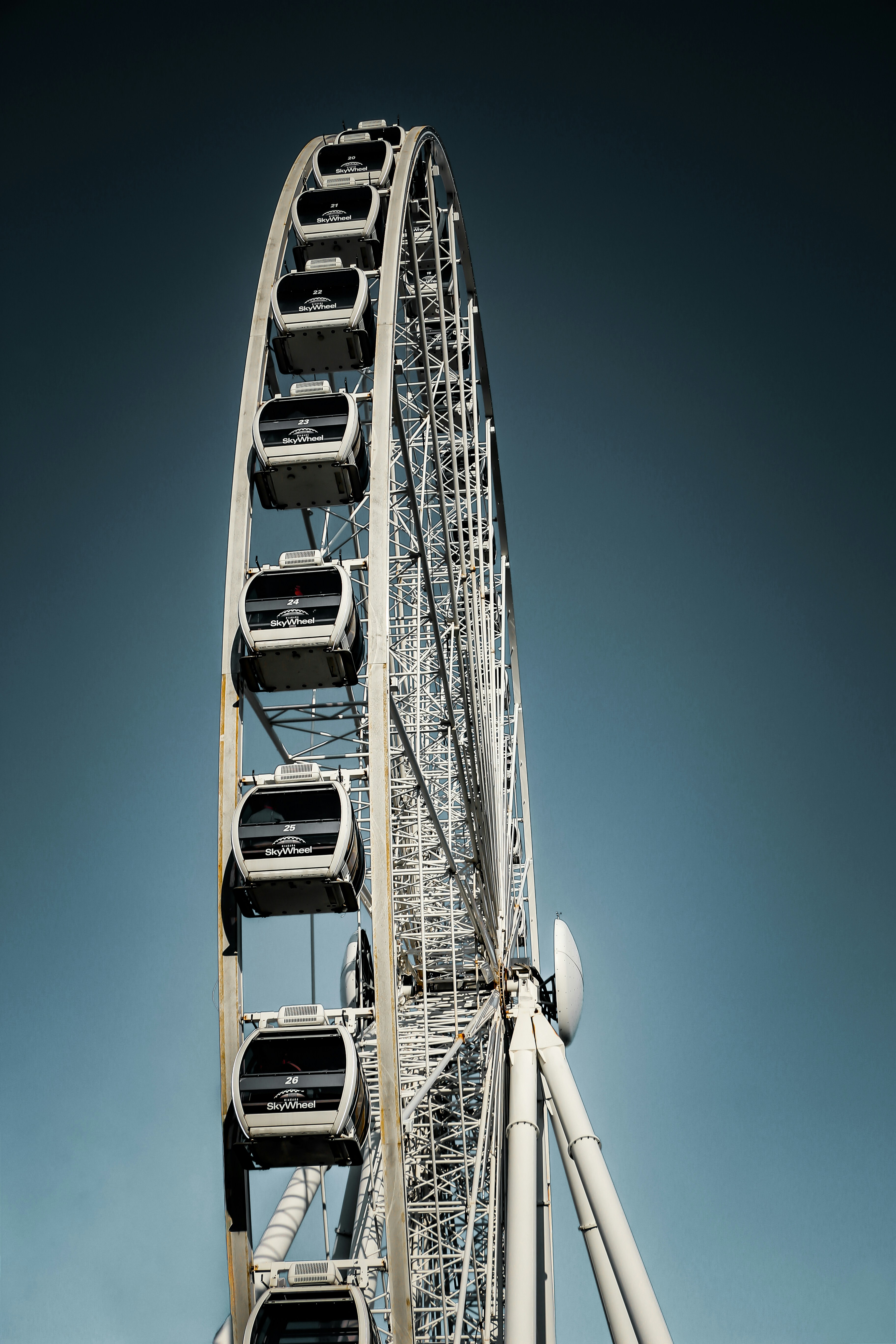 Vertical Giant: A Ferris Wheel Reaching Toward a Deep Blue Sky