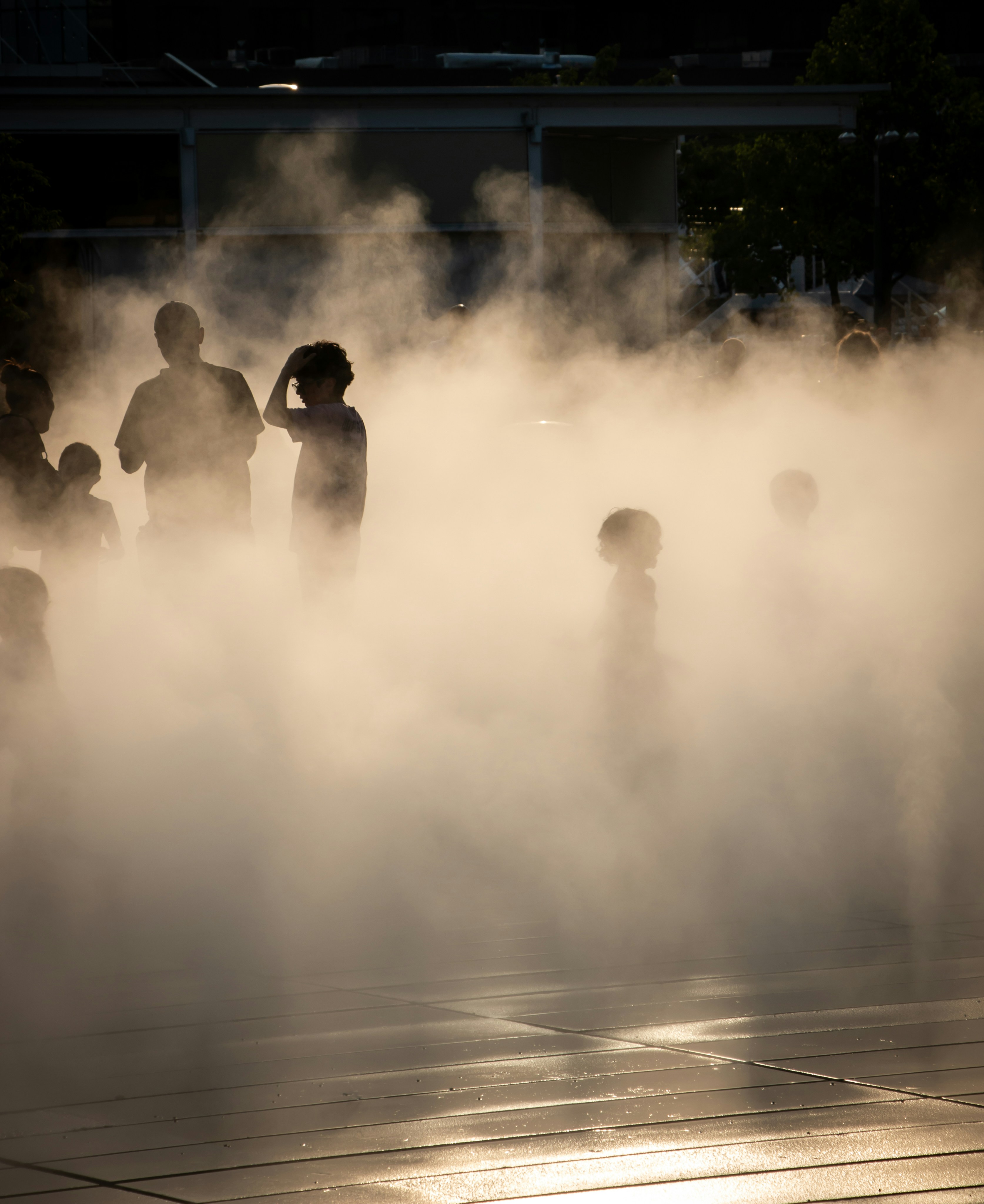 Steam silhouettes in a sunlit plaza