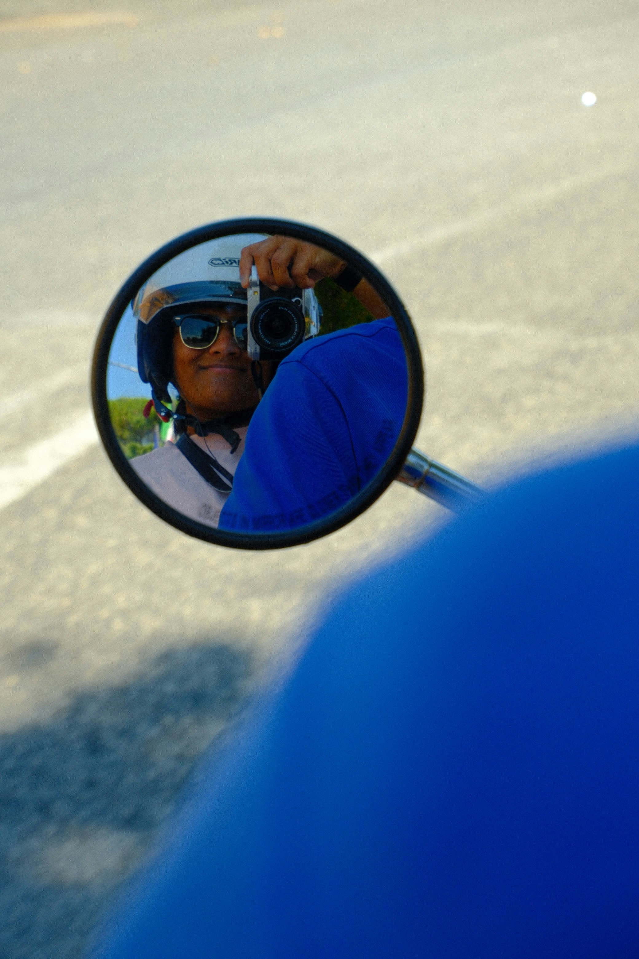 Mirror Moment: Rider and Photographer Reflected in a Bike Helmet Mirror