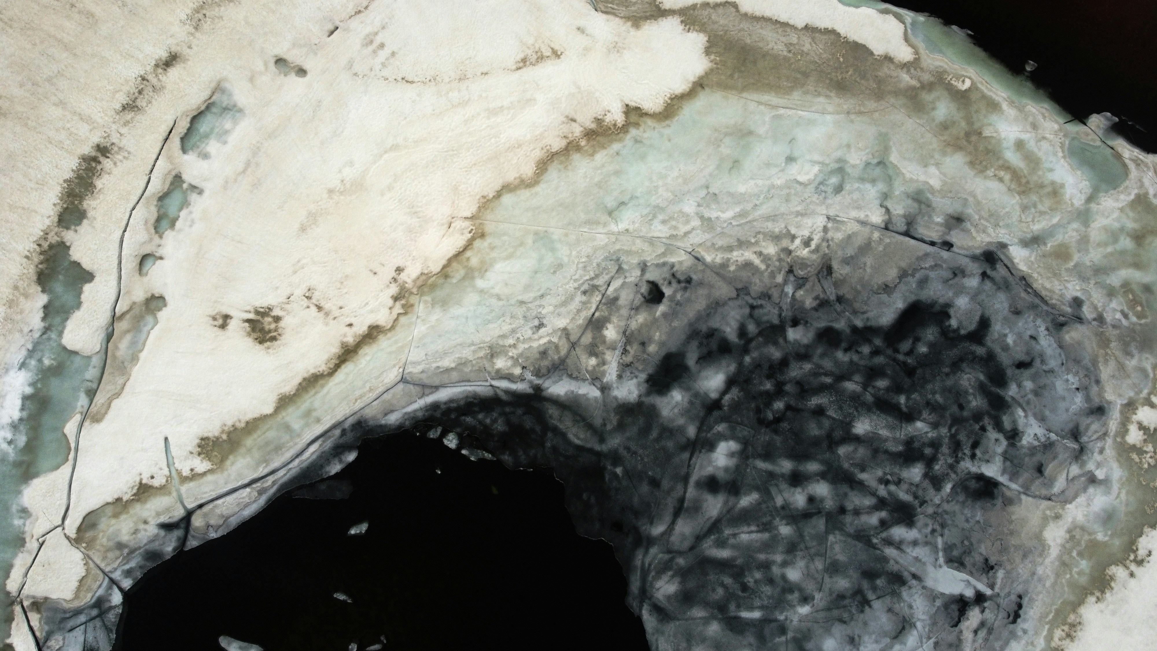 Desolate Crater Rim: Aerial View into a Moonlit Basin