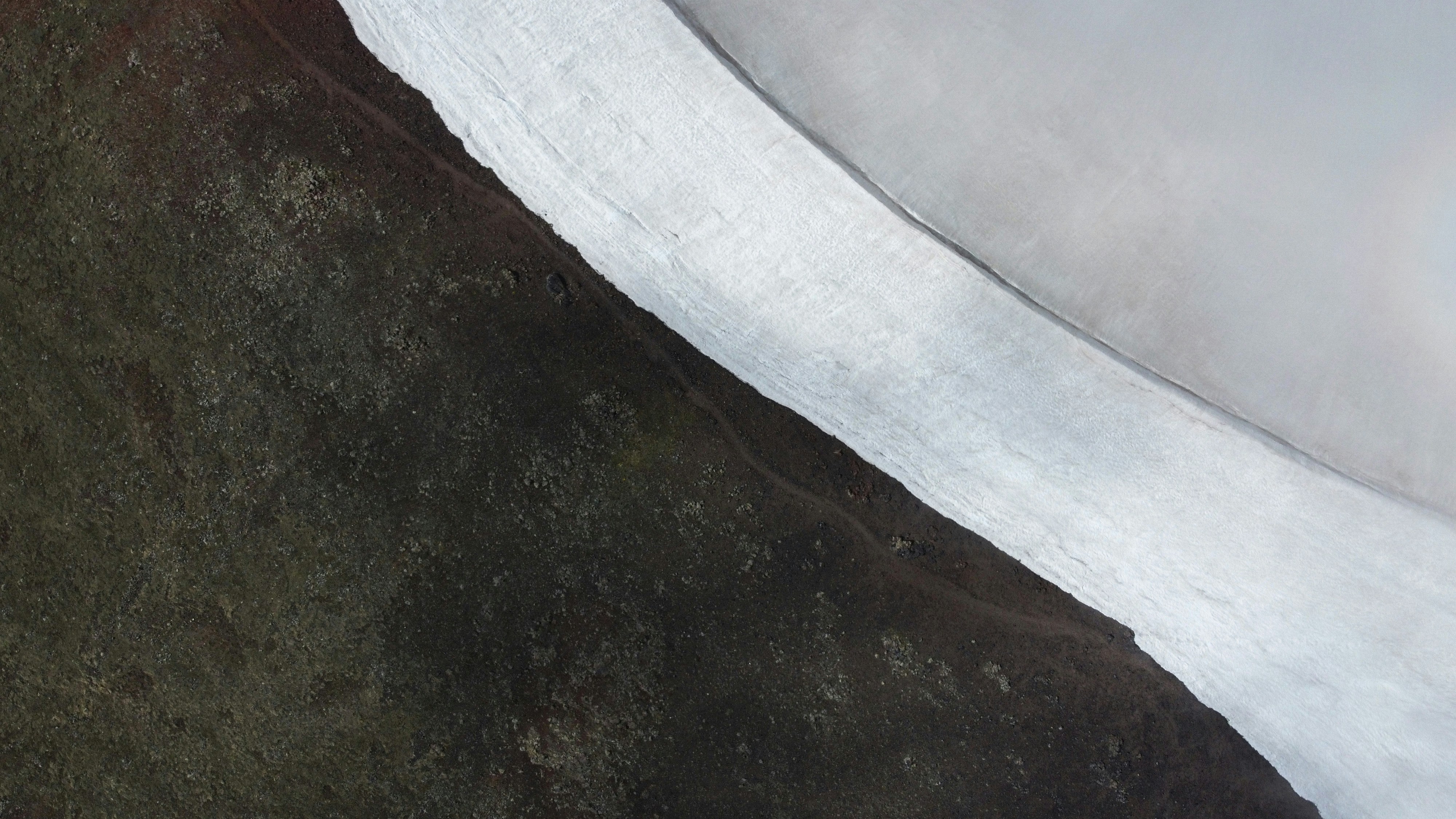 Curved Boundary Over a Windswept Slope