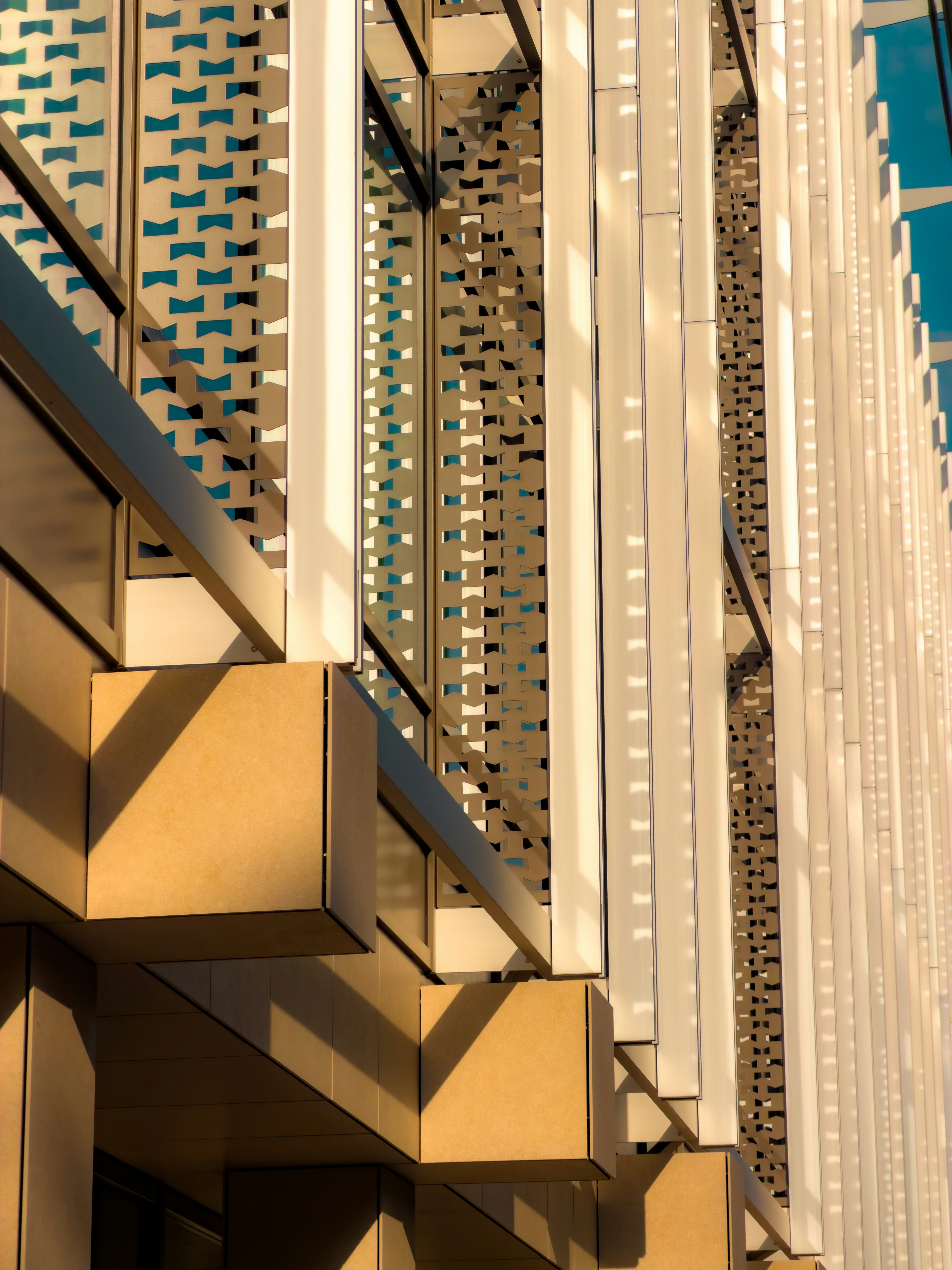 Vertical Light: Aqua-Concrete Facade in Warm Geometry