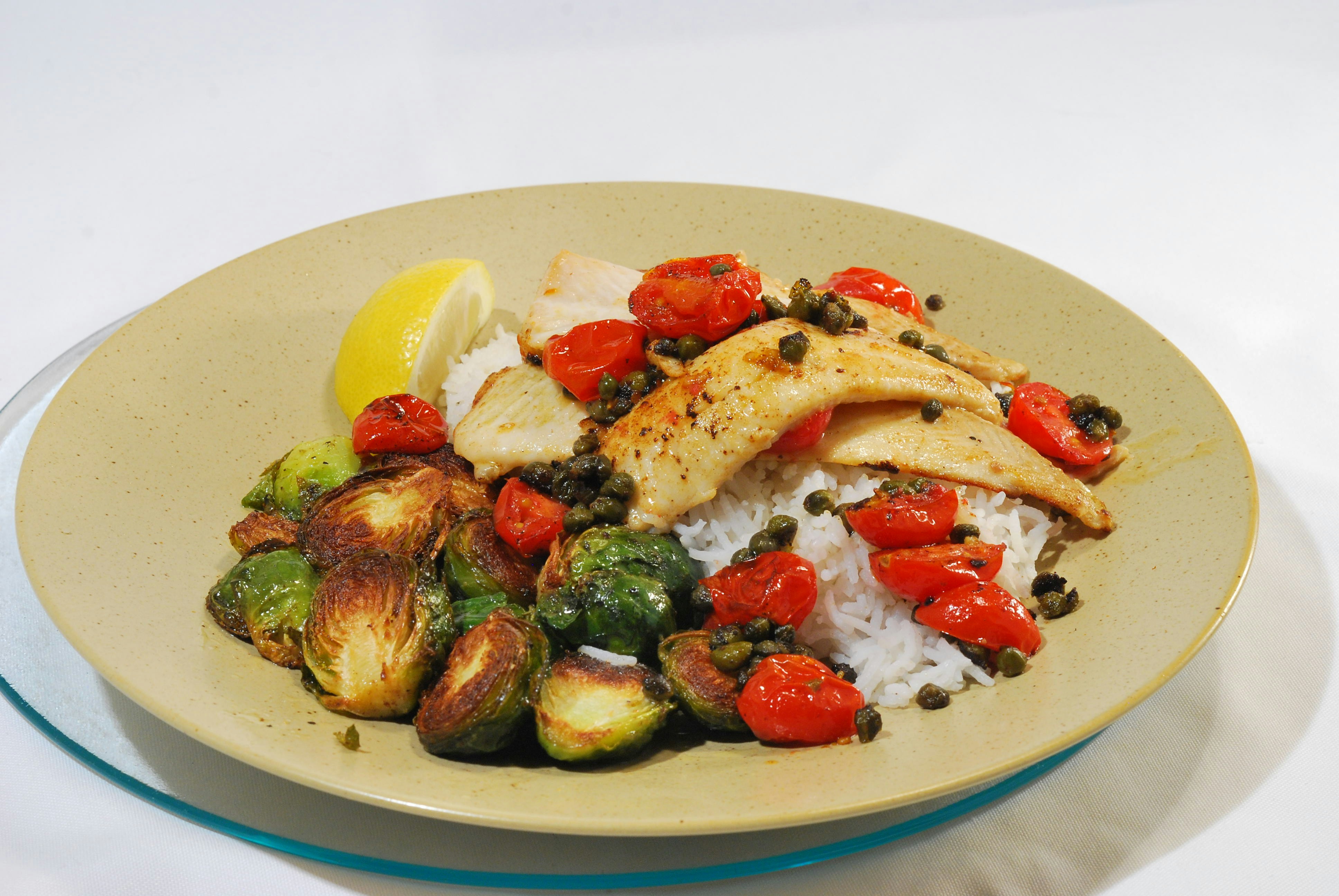 Citrus-Glazed Fish with Charred Brussels and Cherry Tomatoes Over Fragrant Rice