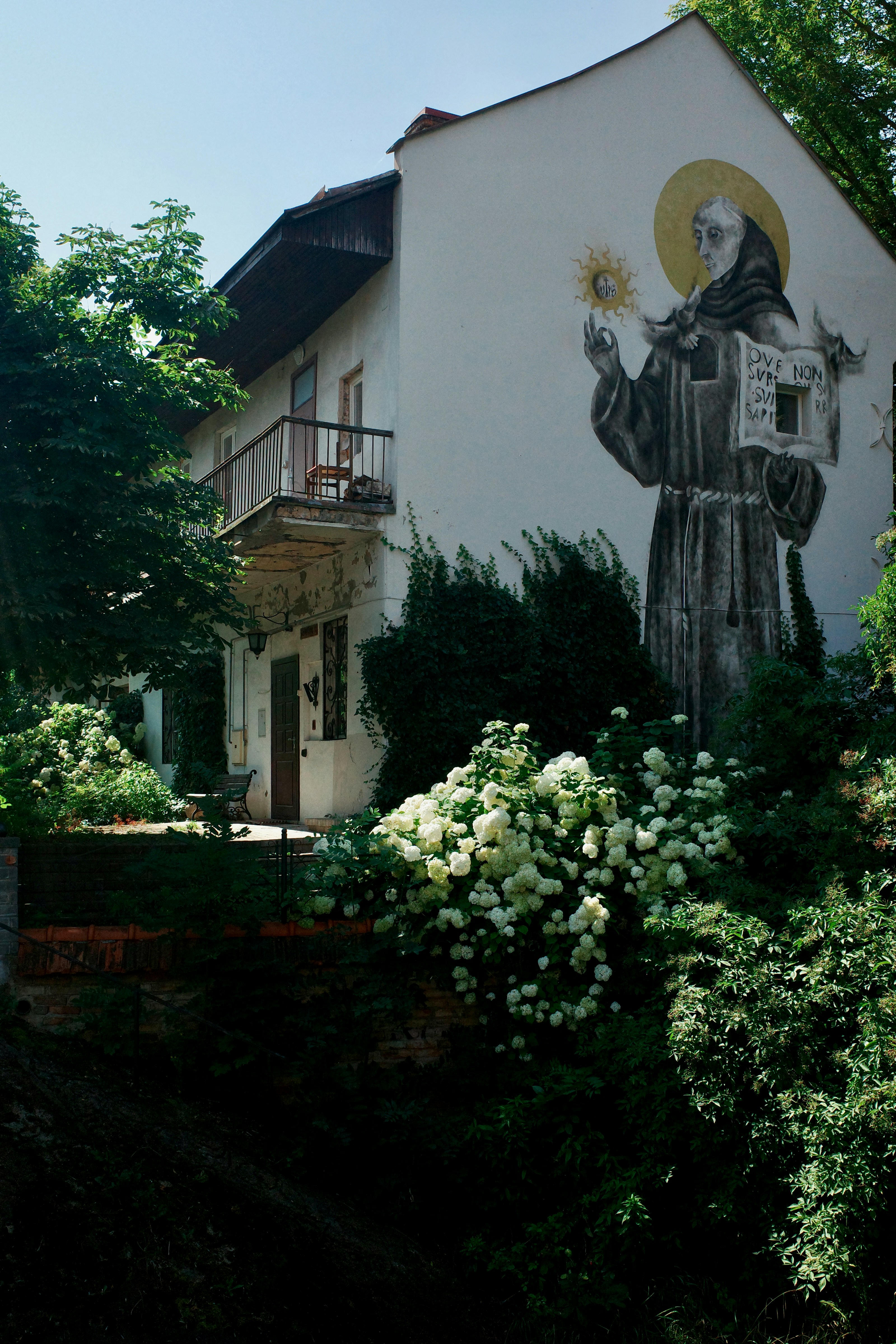 Mural Saint: A Quiet Guardian on a Sunlit Facade