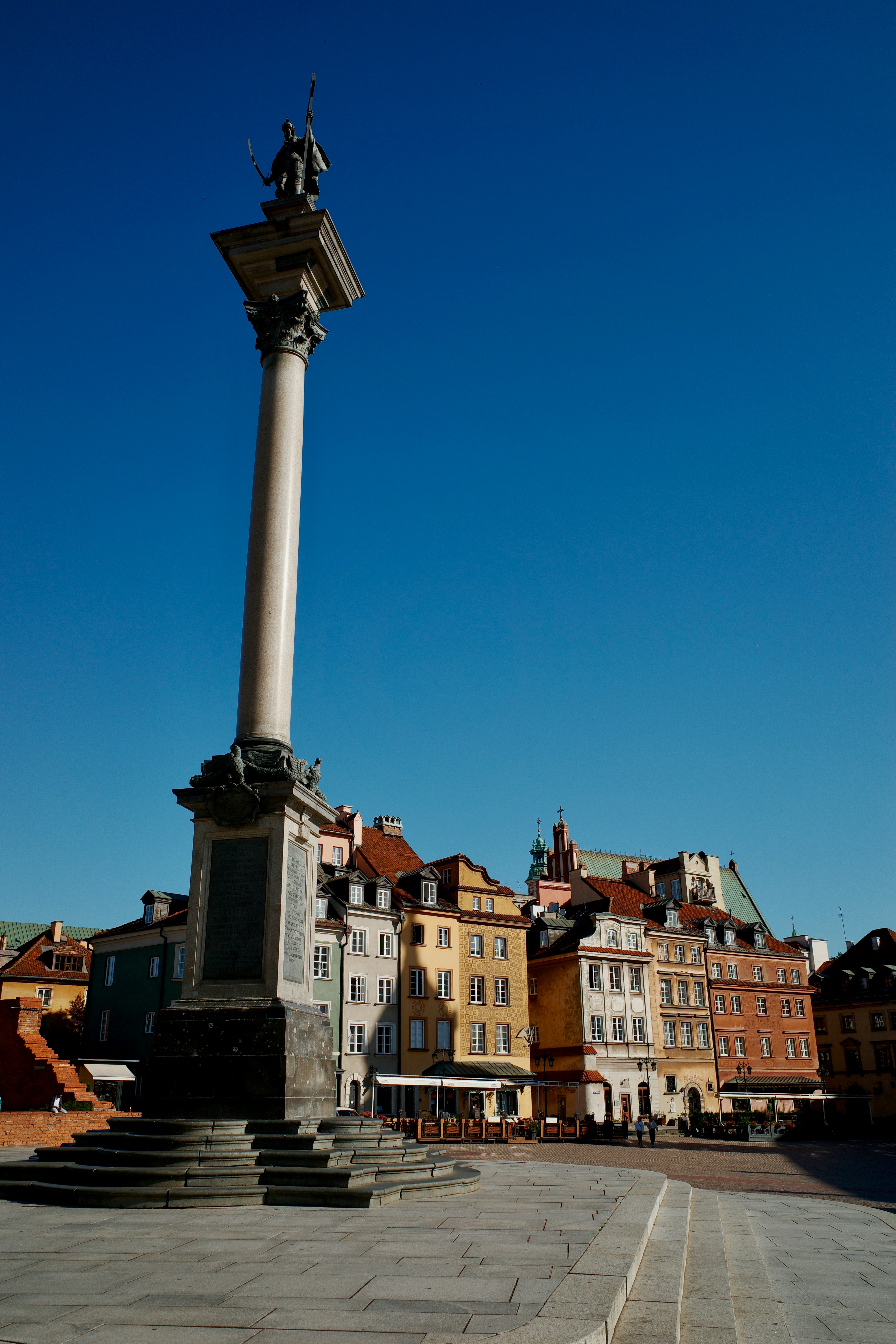 Column of the Square: A Monumental Cornerstone Amid Colorful Facades