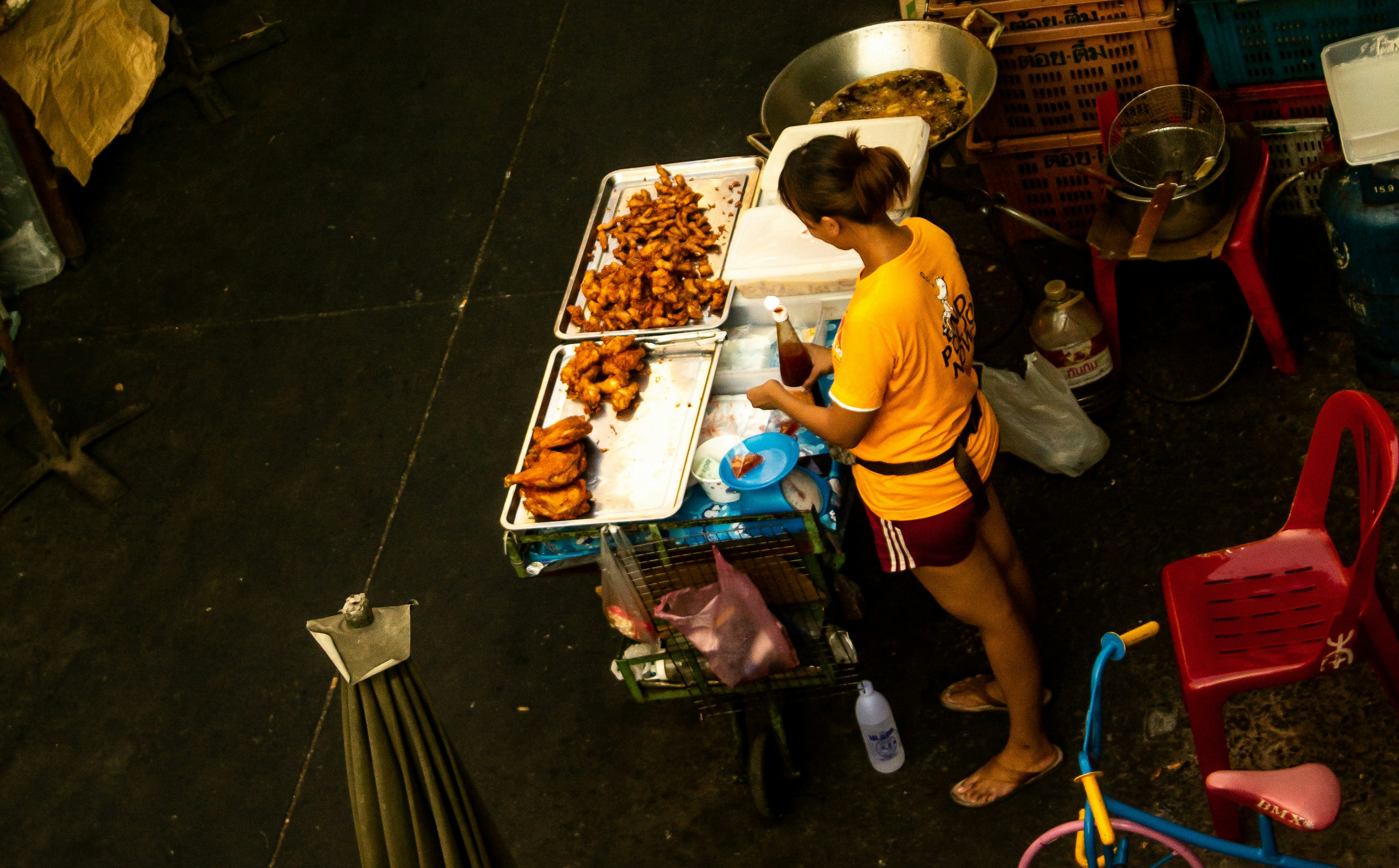 Street Kitchen Stroll: Vendor at Work in a Busy Open-Air Market