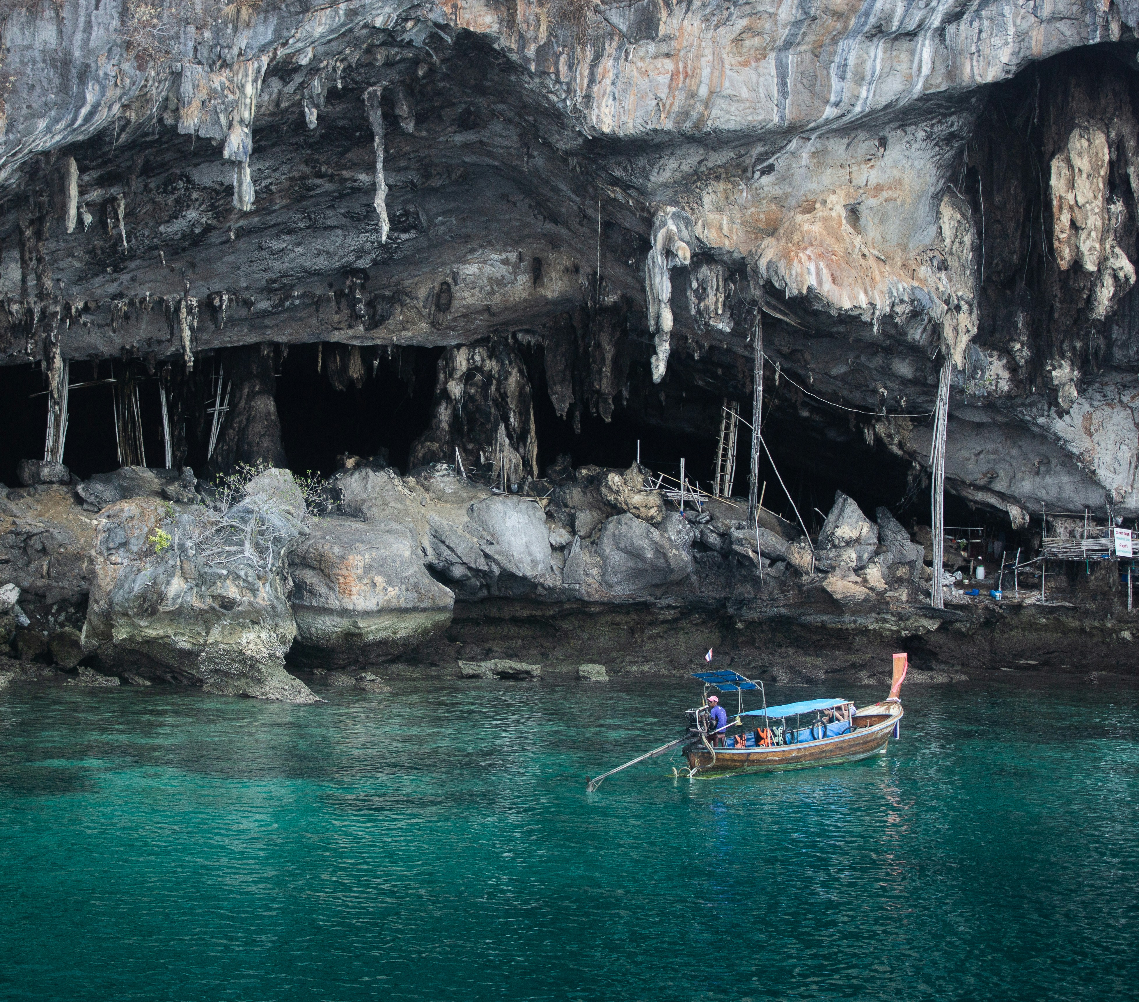 Boat at the Caveland Edge: A Teal Sea Above the Stony Door