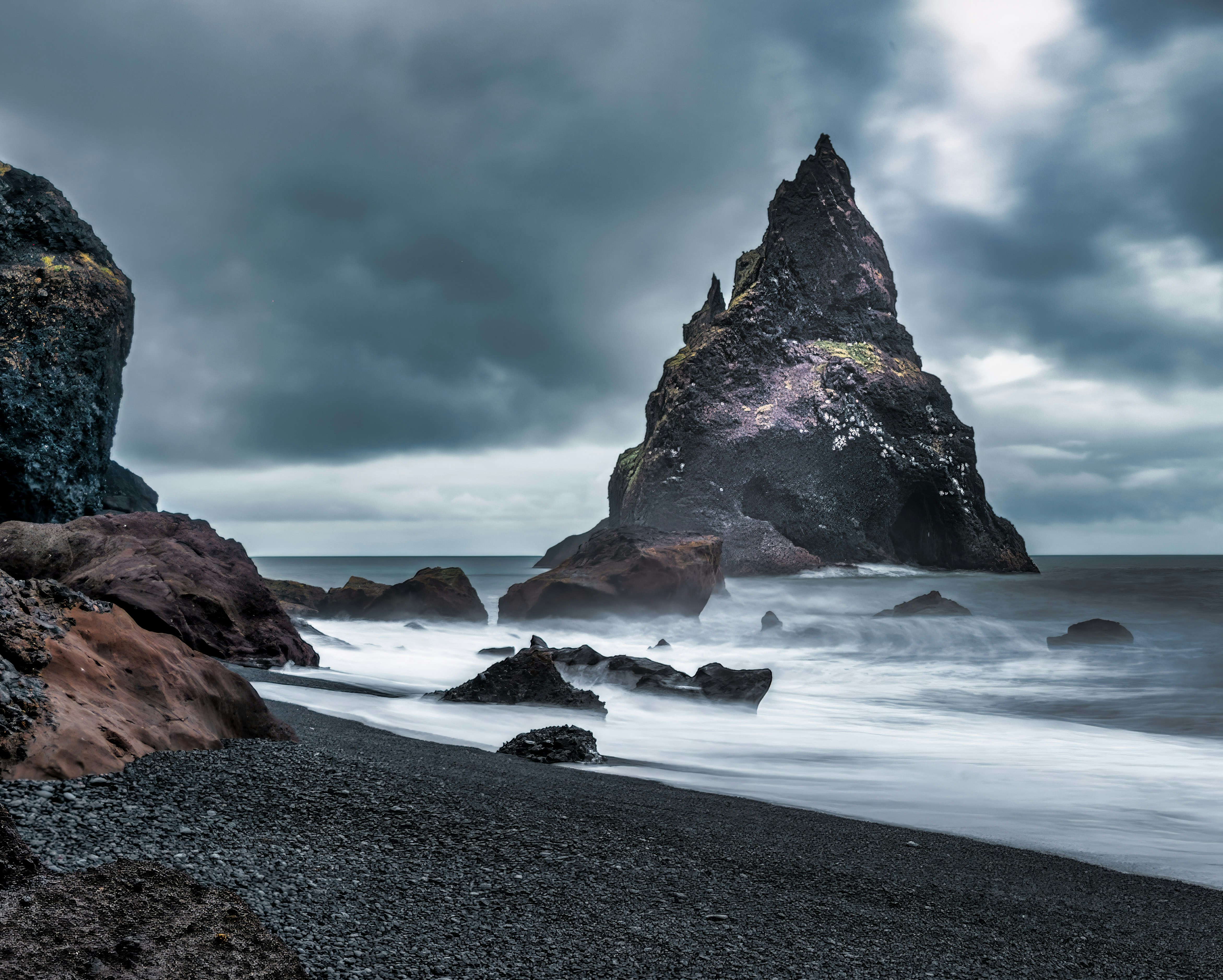 Midnight Sea Sentinel: A basaltic promontory rising from a quiet shore