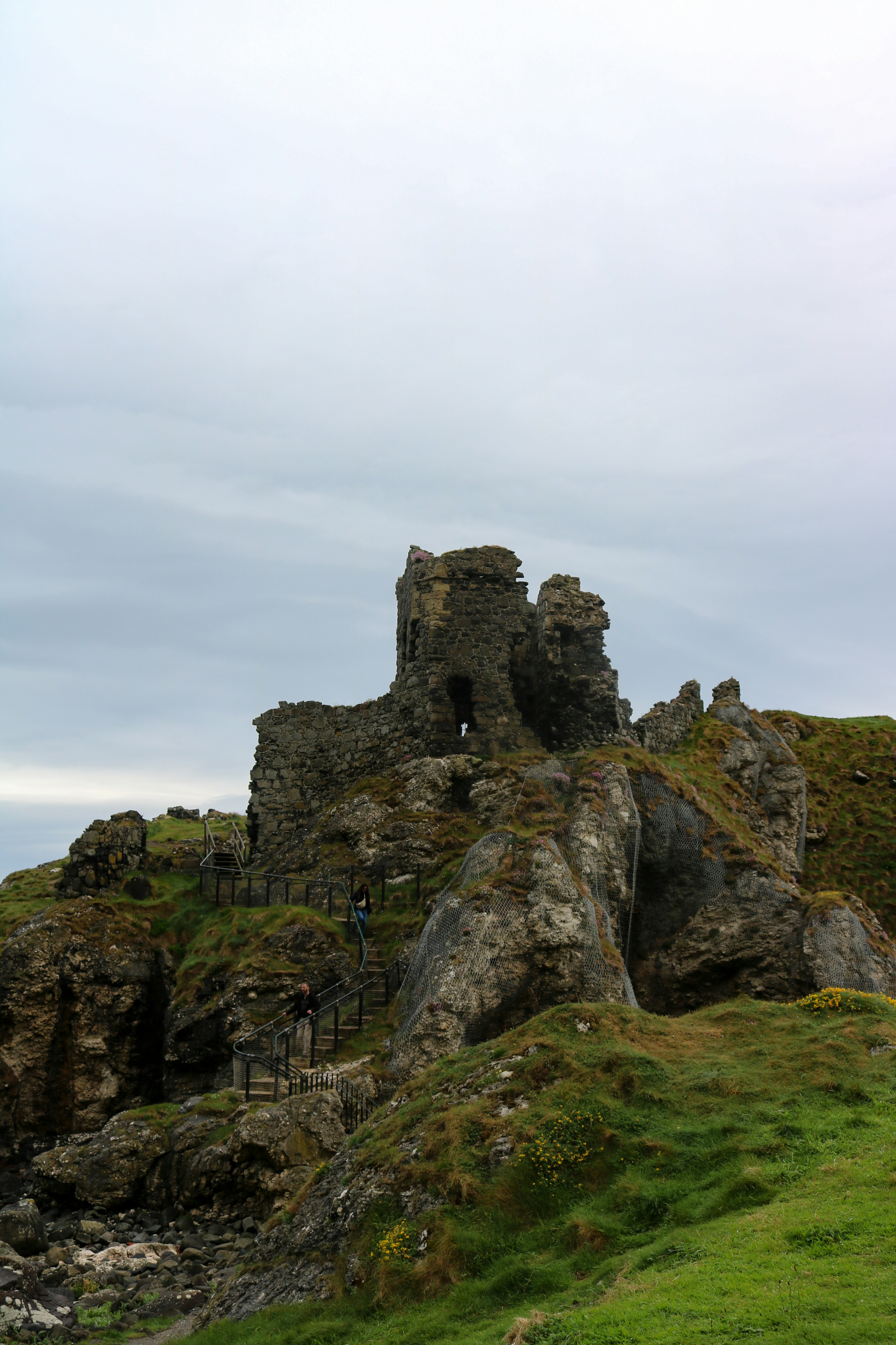 Ruin on the Ridge: Weathered Stone Among Green Slopes