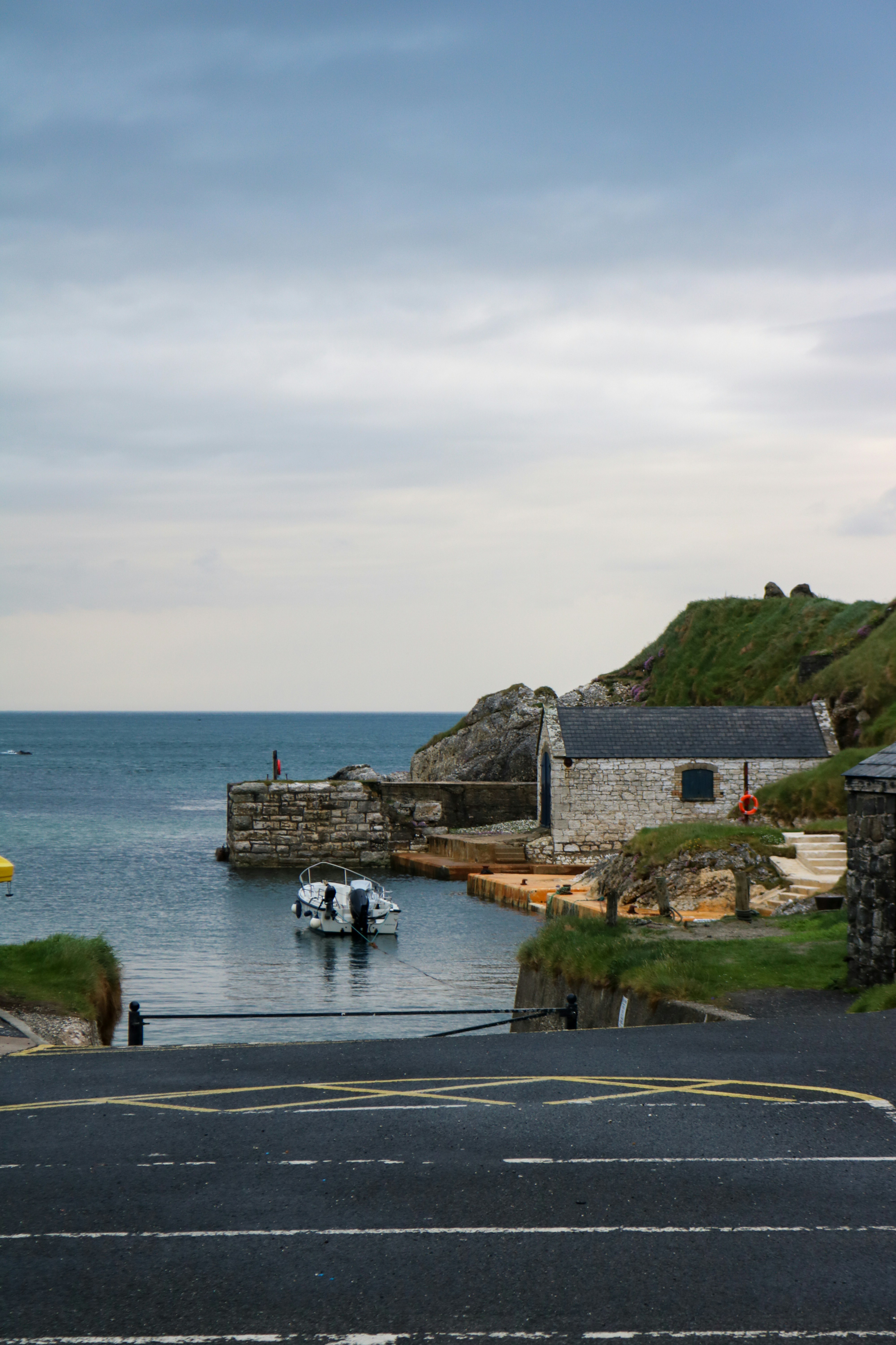 Harbor at Dusk: Stone Quay and Calm Boat