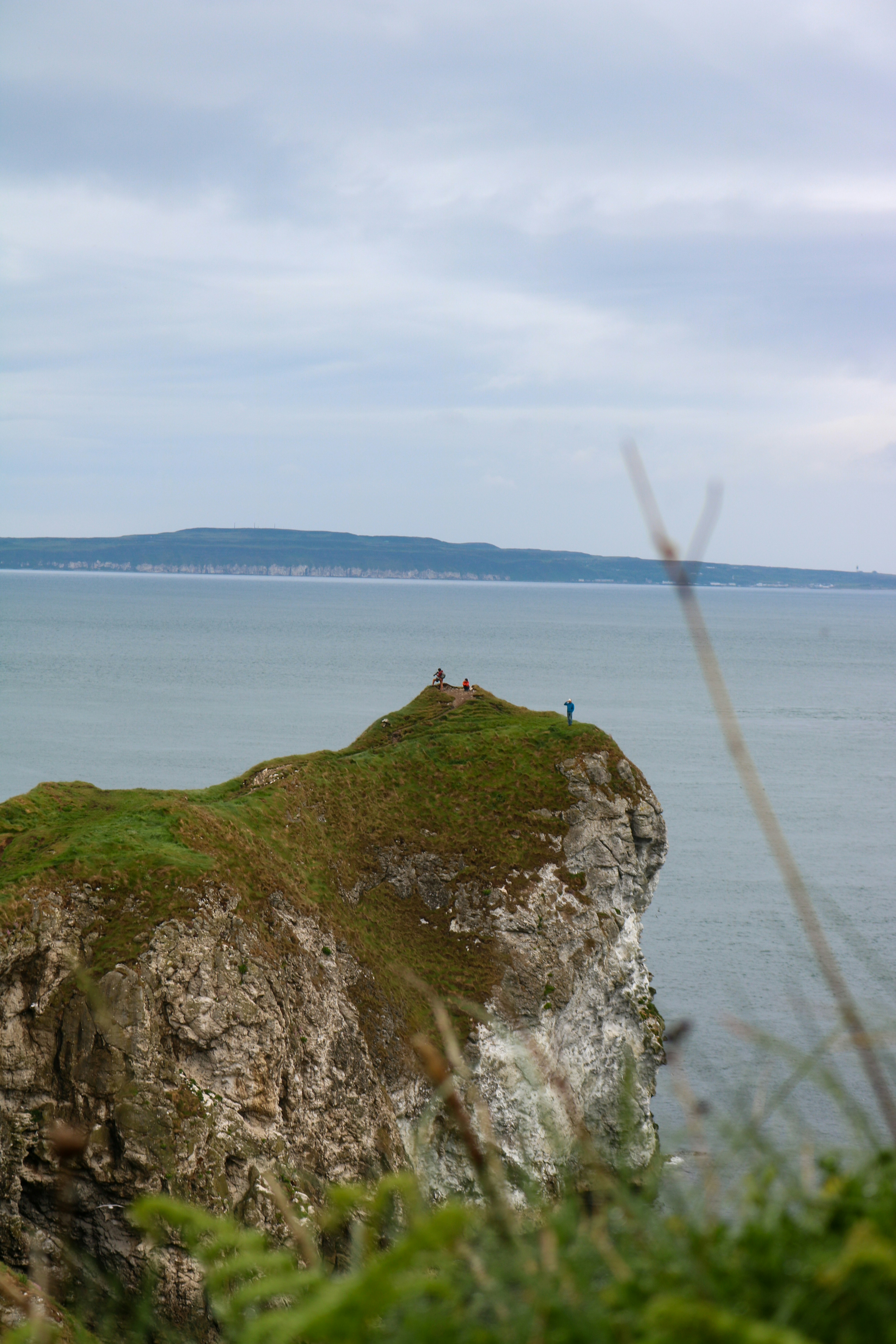 Clifftop silhouettes: hikers at the edge of the sea