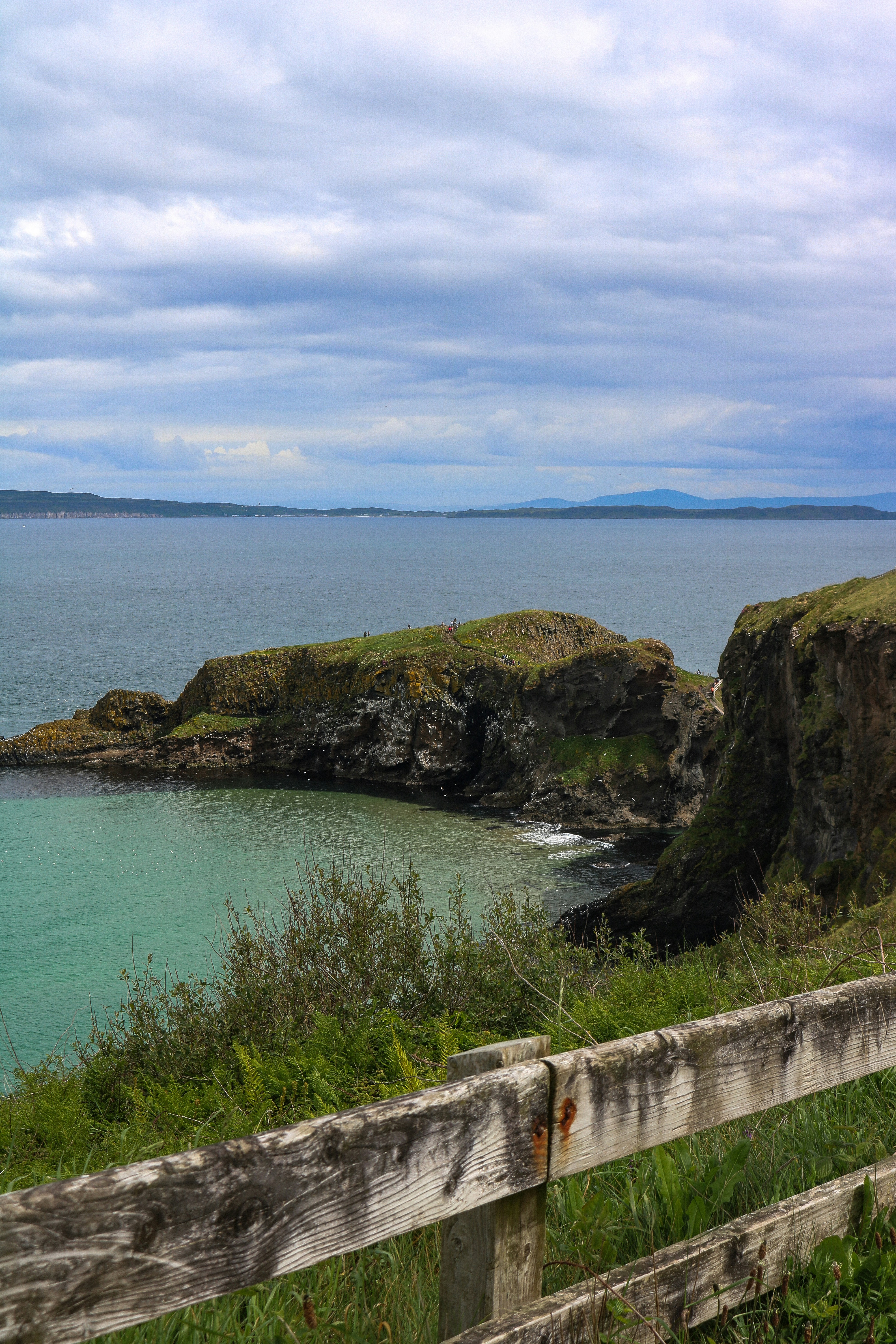 Cliffside Tides: A Grassy Peninsula Fringing Turquoise Waters