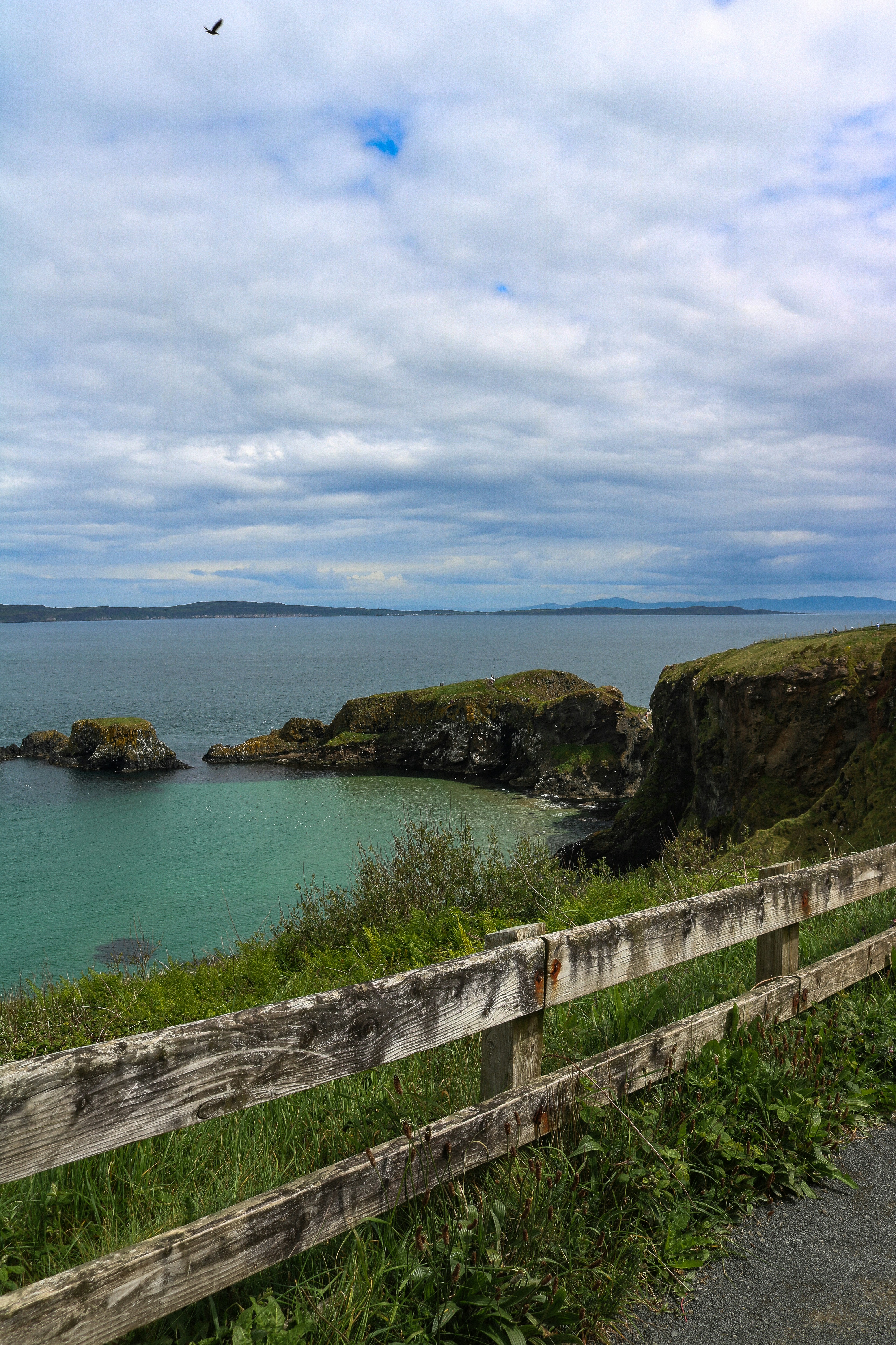 Clifftop View over Turquoise Cove with Weathered Fence