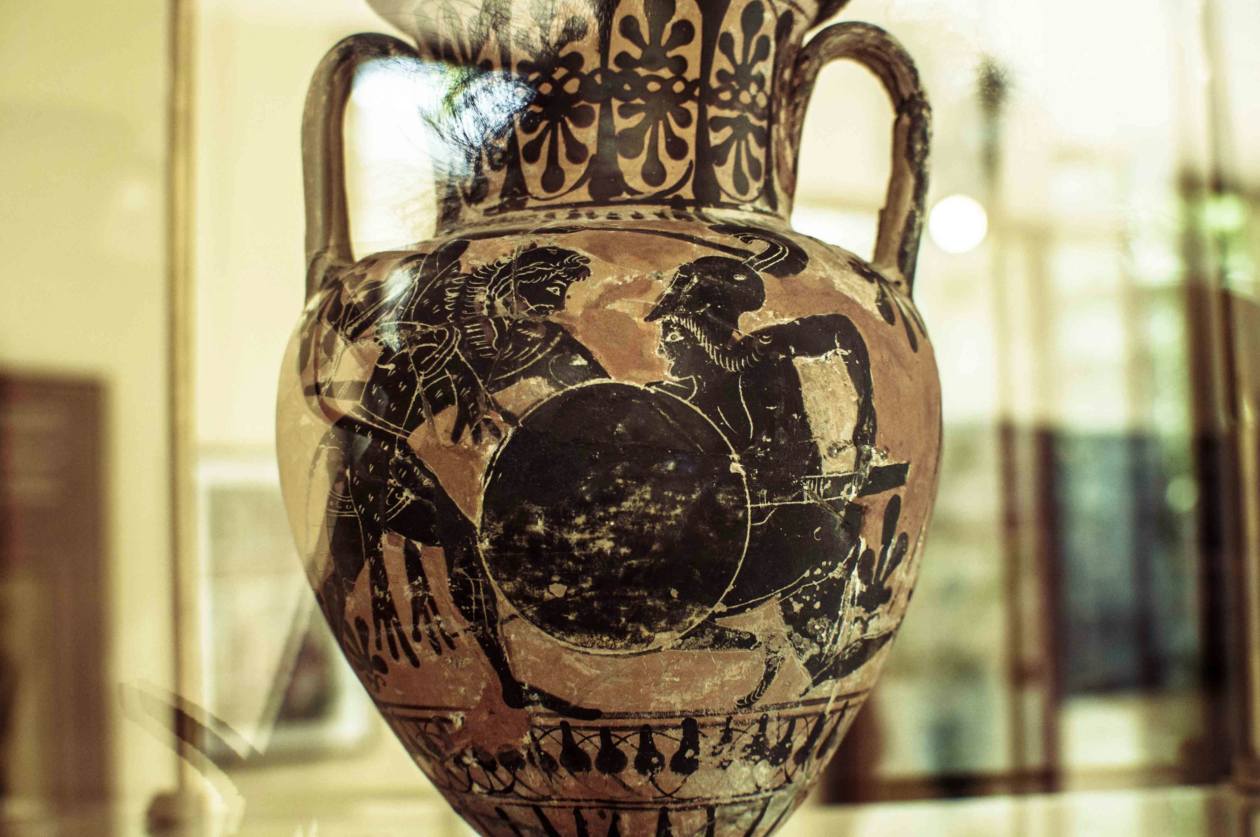 Ancient Vase Portrait: Painted Figures on a Historic Cratered Jug