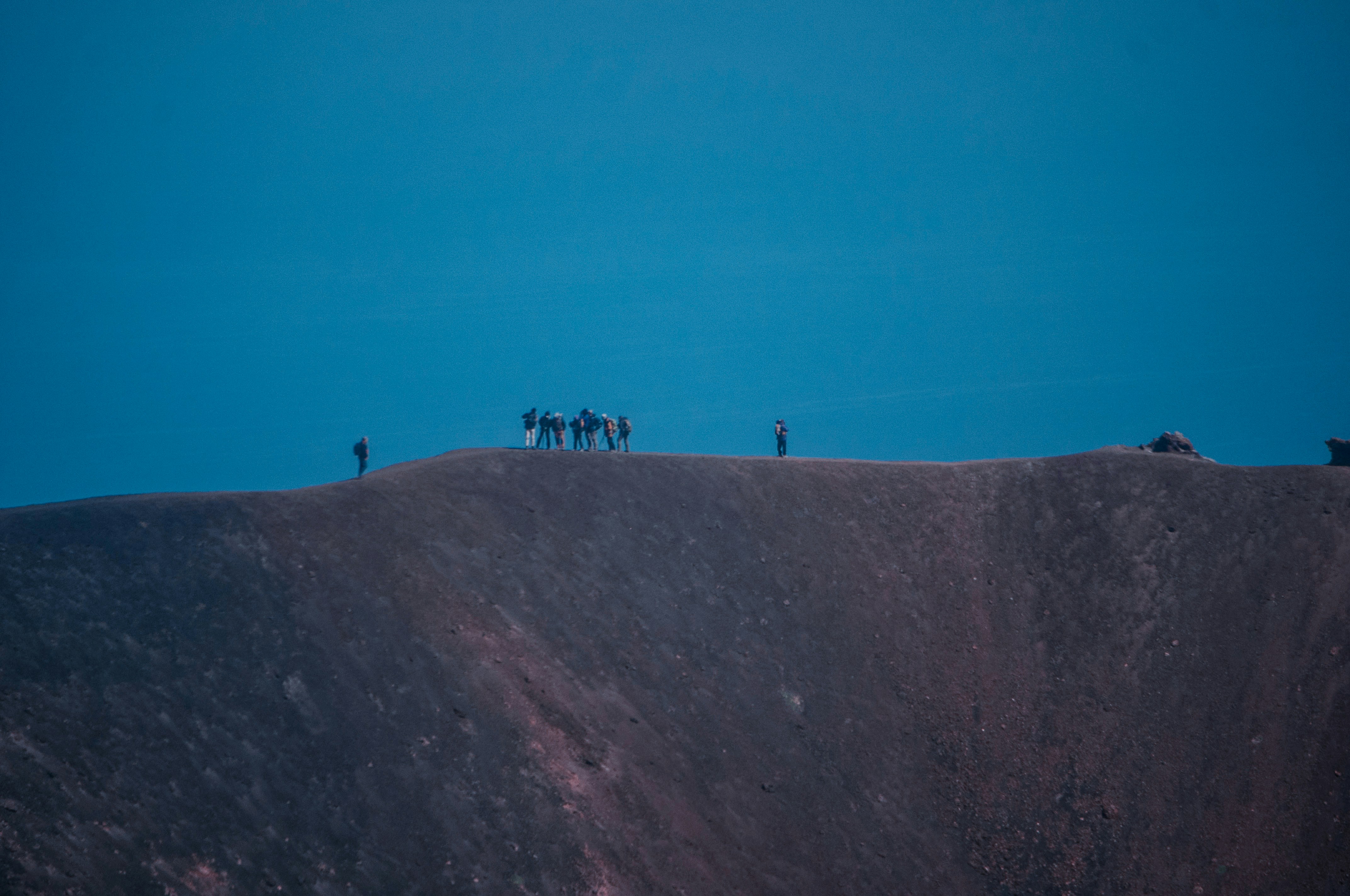 Distant Silhouettes on a Martian Ridge Under a Quiet Blue Sky