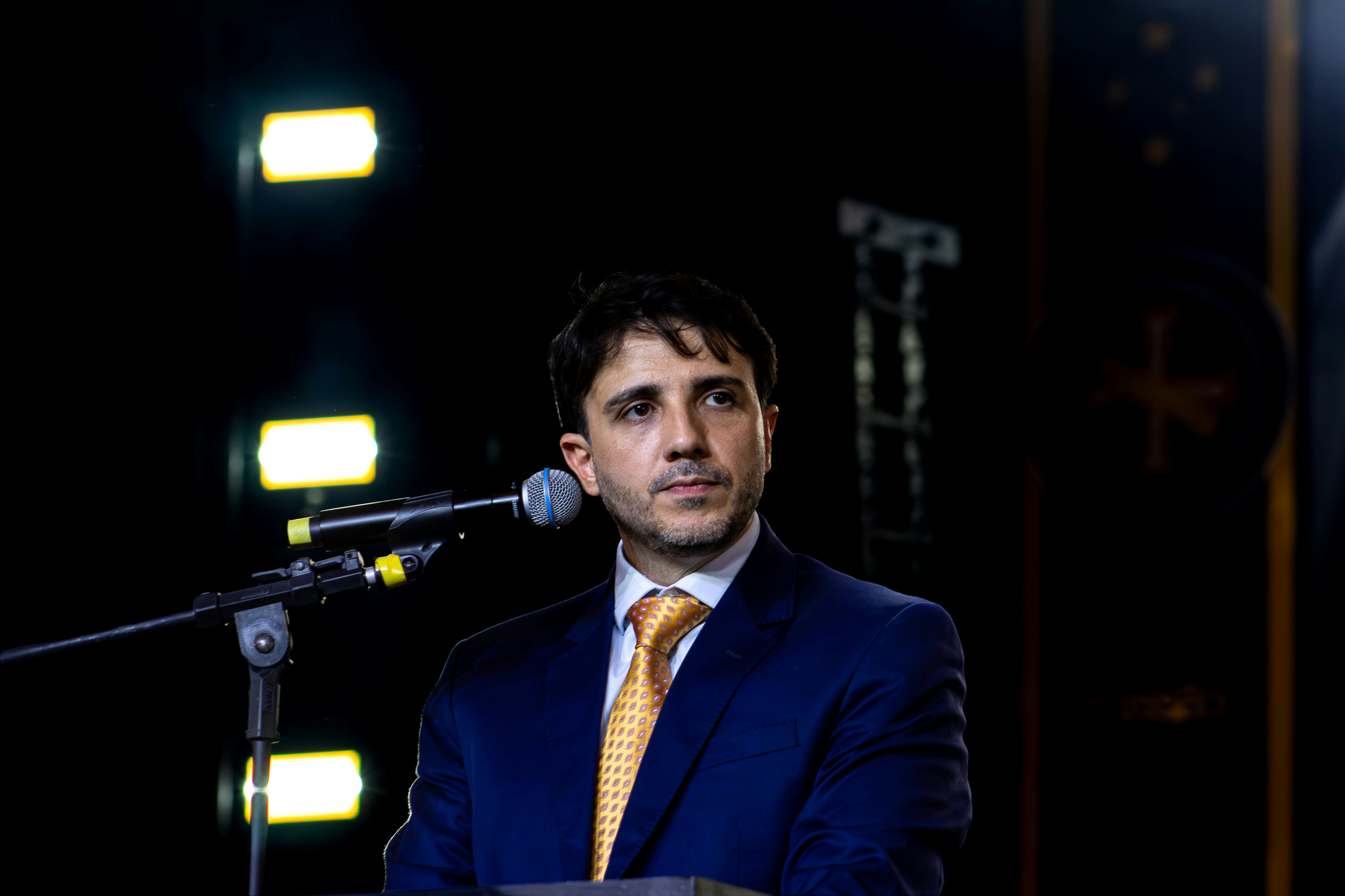 Speaker at the Podium: A Formal Address in Blue