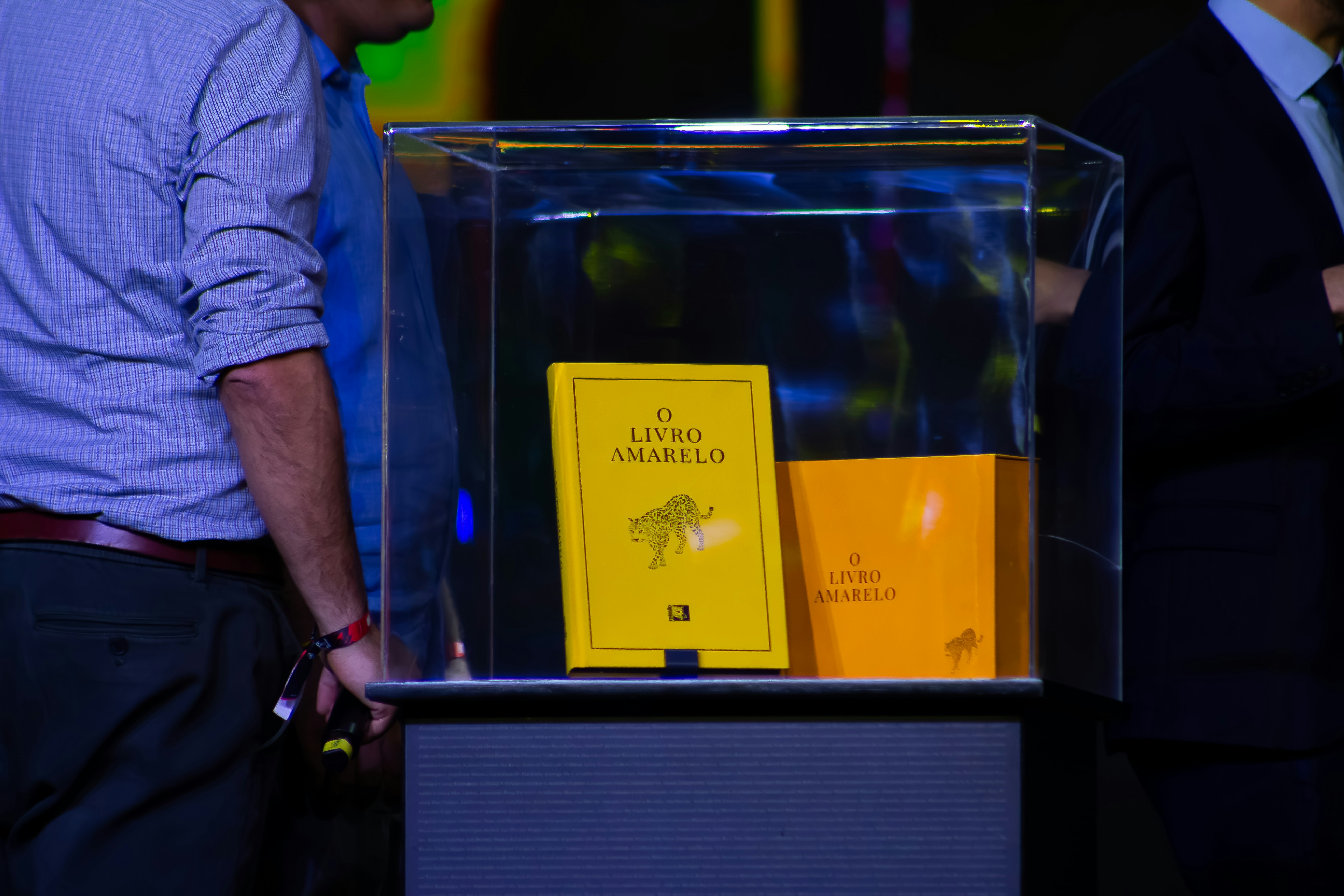 Yellow book in a glass display: a bold centerpiece on a dim stage