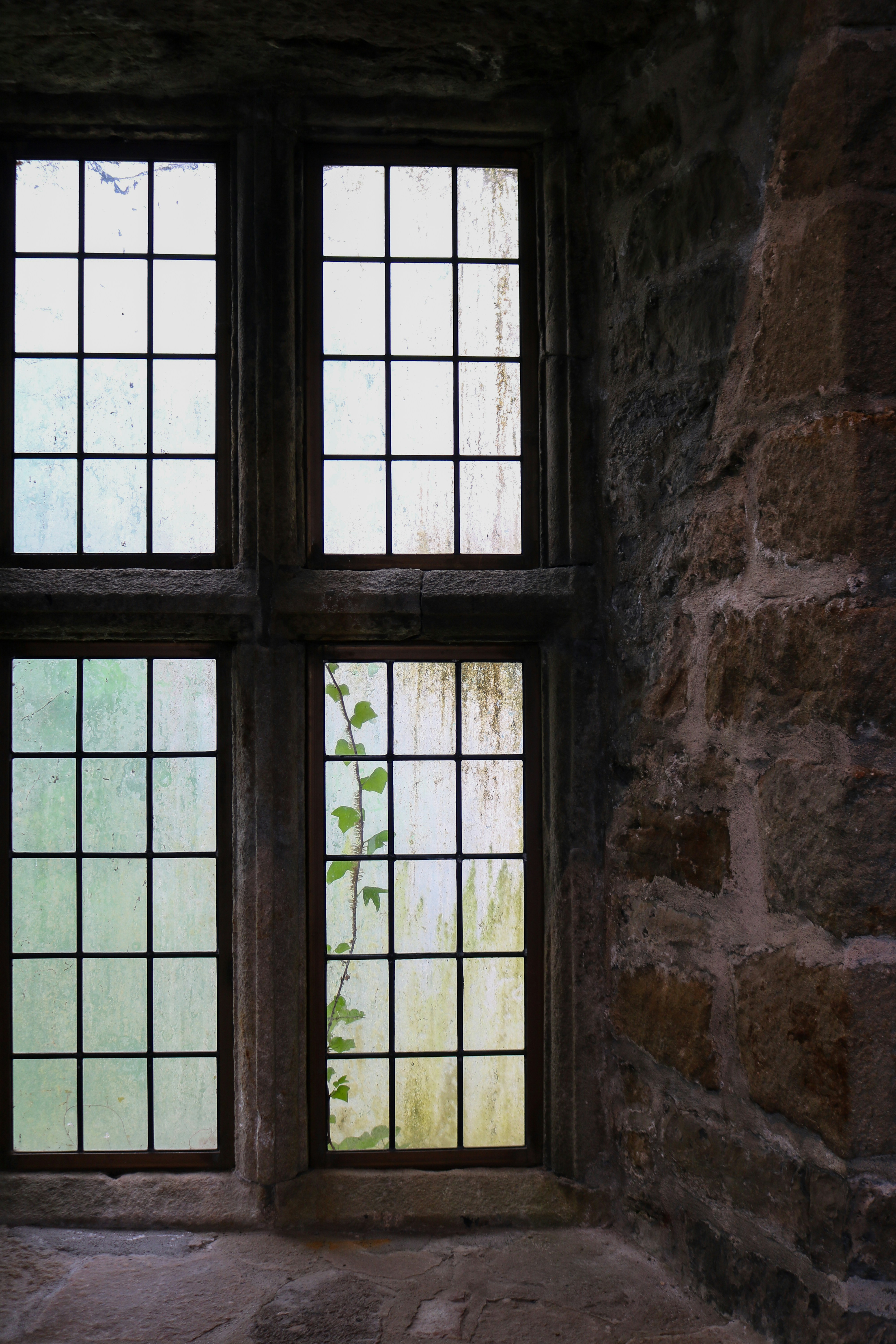 Soft Light Through A Weathered Window in a Stone Wall
