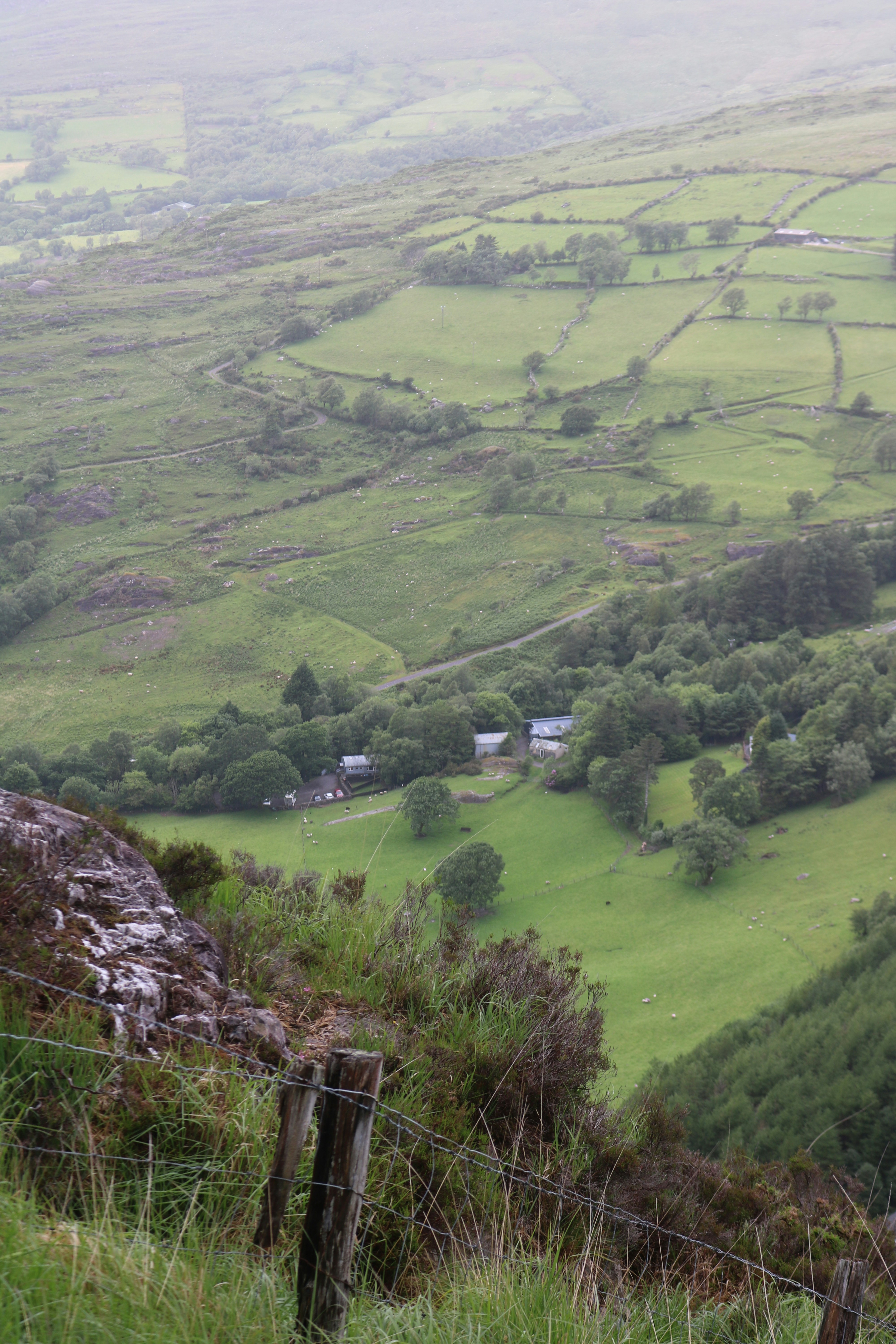 A Green Valley Terrace with Stone Walls and Farmsteads From a Mountain Outcrop