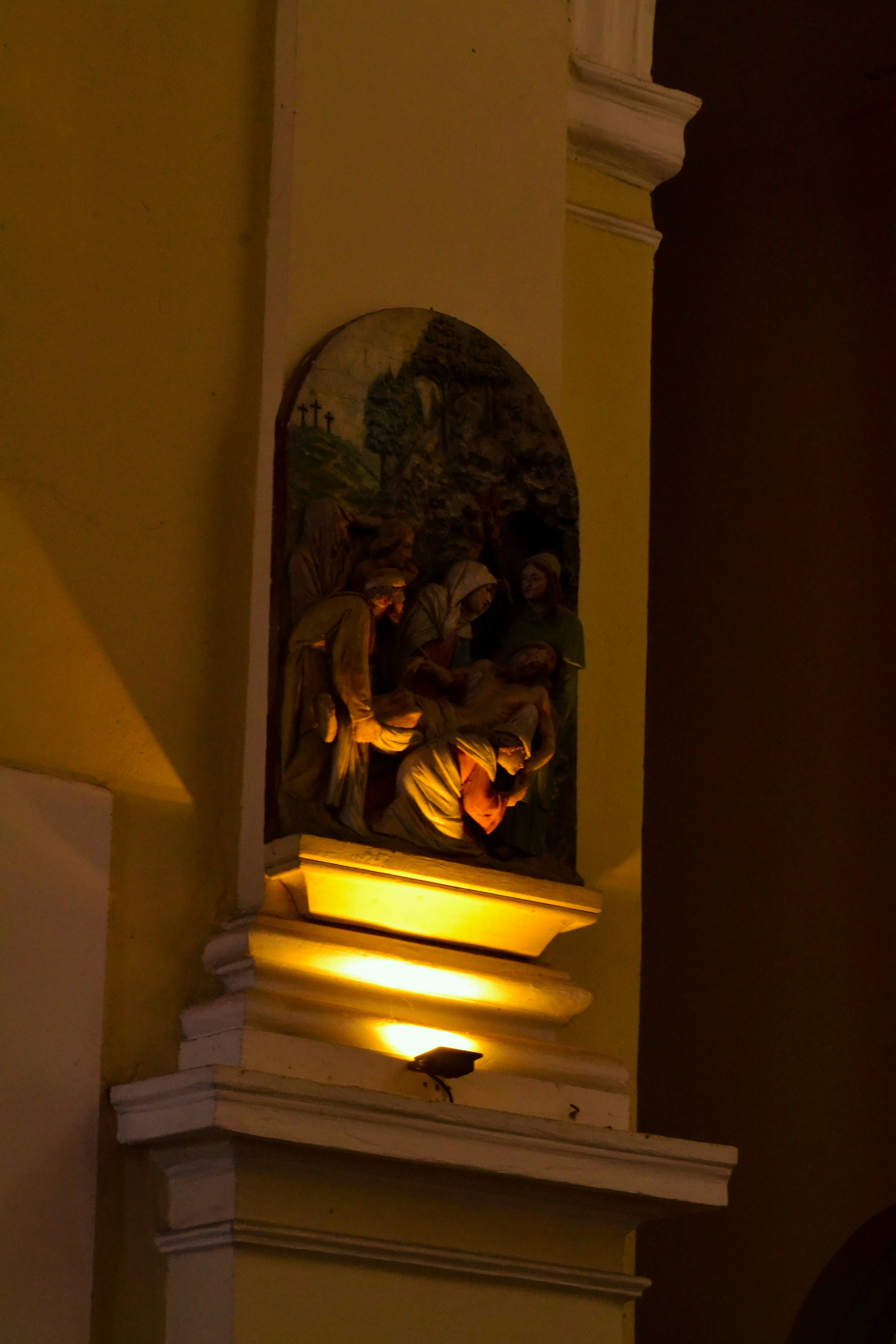 Lit Niche: A Sacred Moment Hidden in Amber Glow