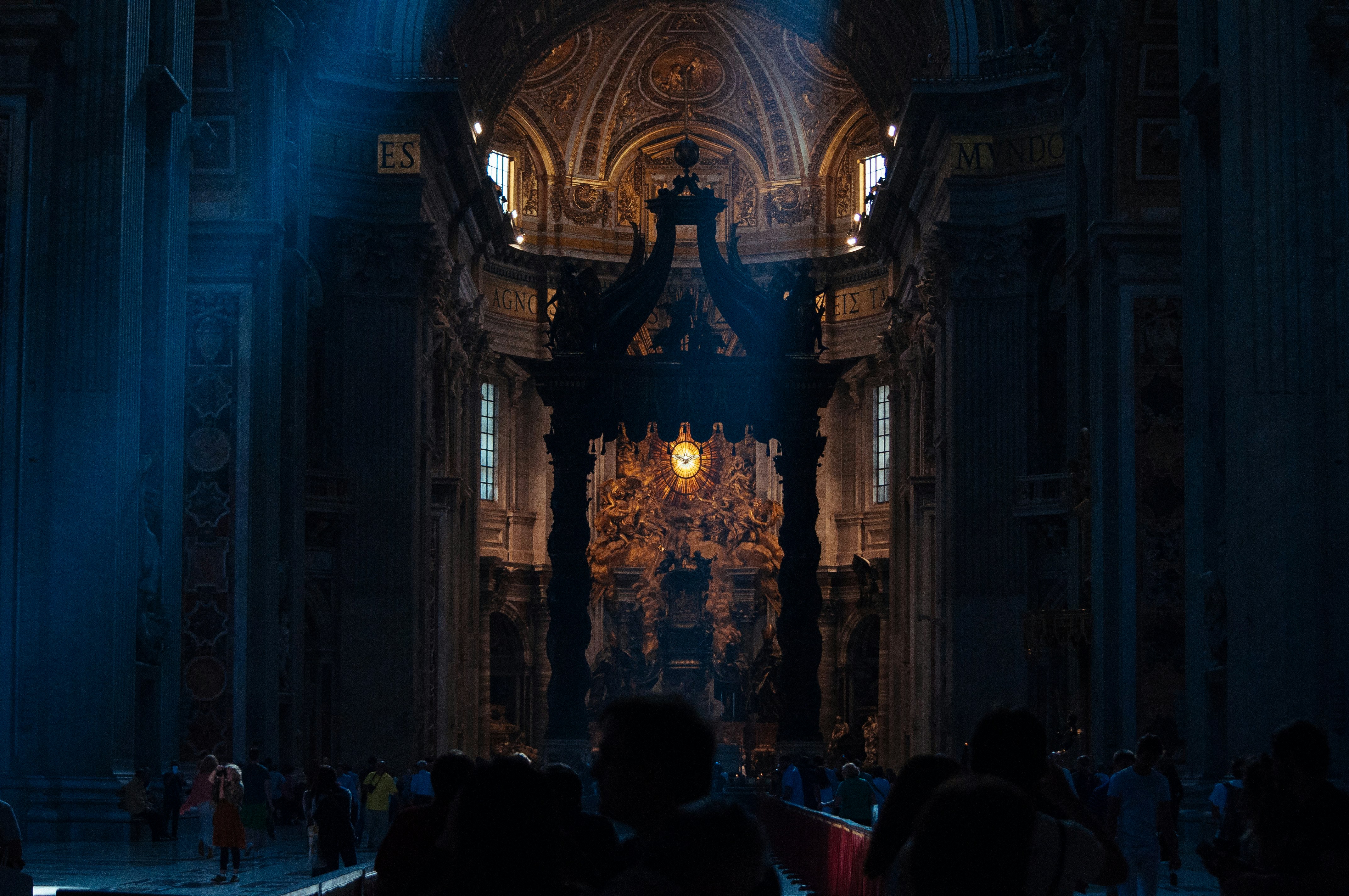 Gilded Chapel Gate: Carved Altar Silhouettes in Dim Cathedral