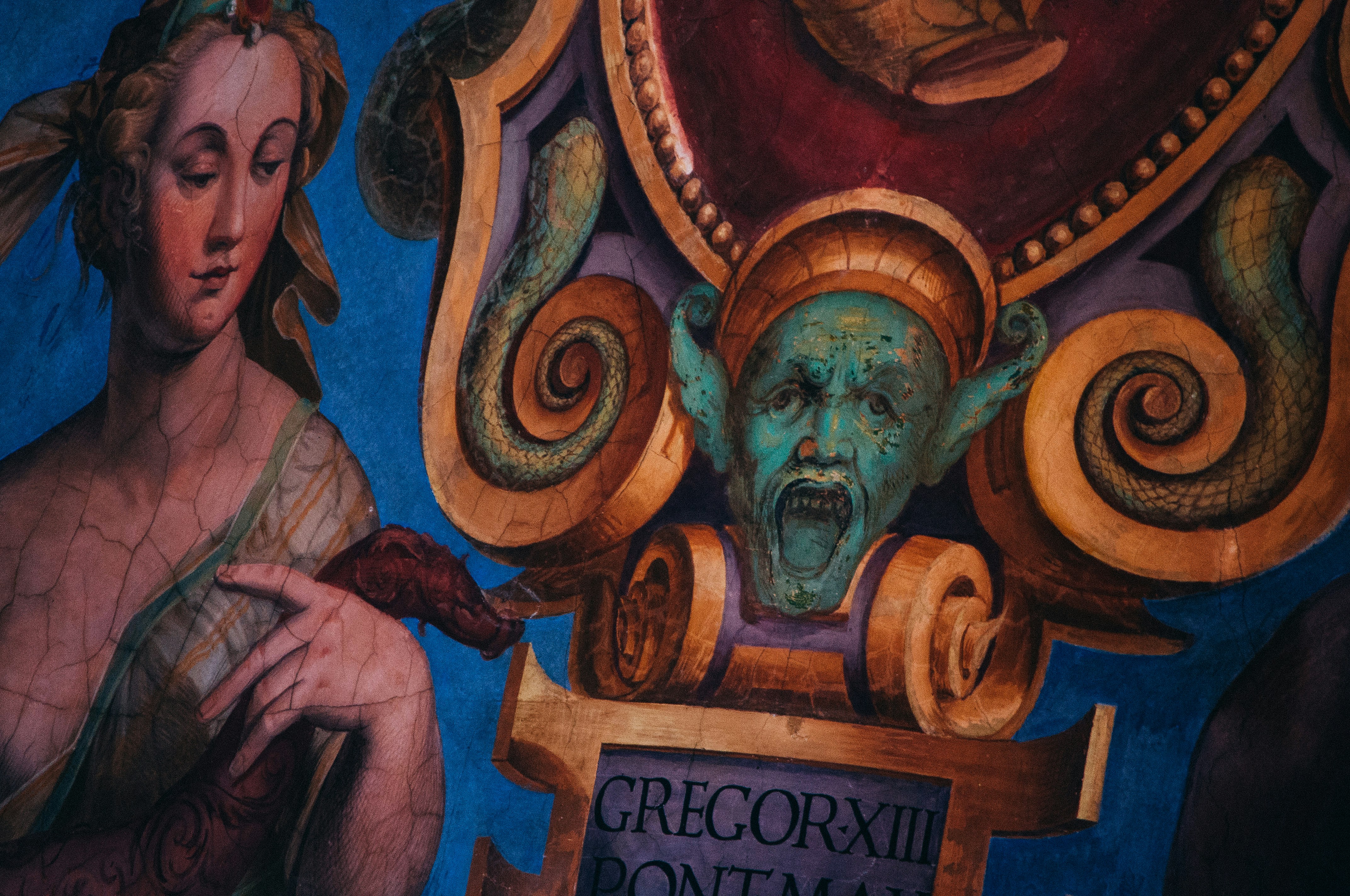 Vivid Cartouche: Turquoise Gargoyle Emerges from a Blue Fresco
