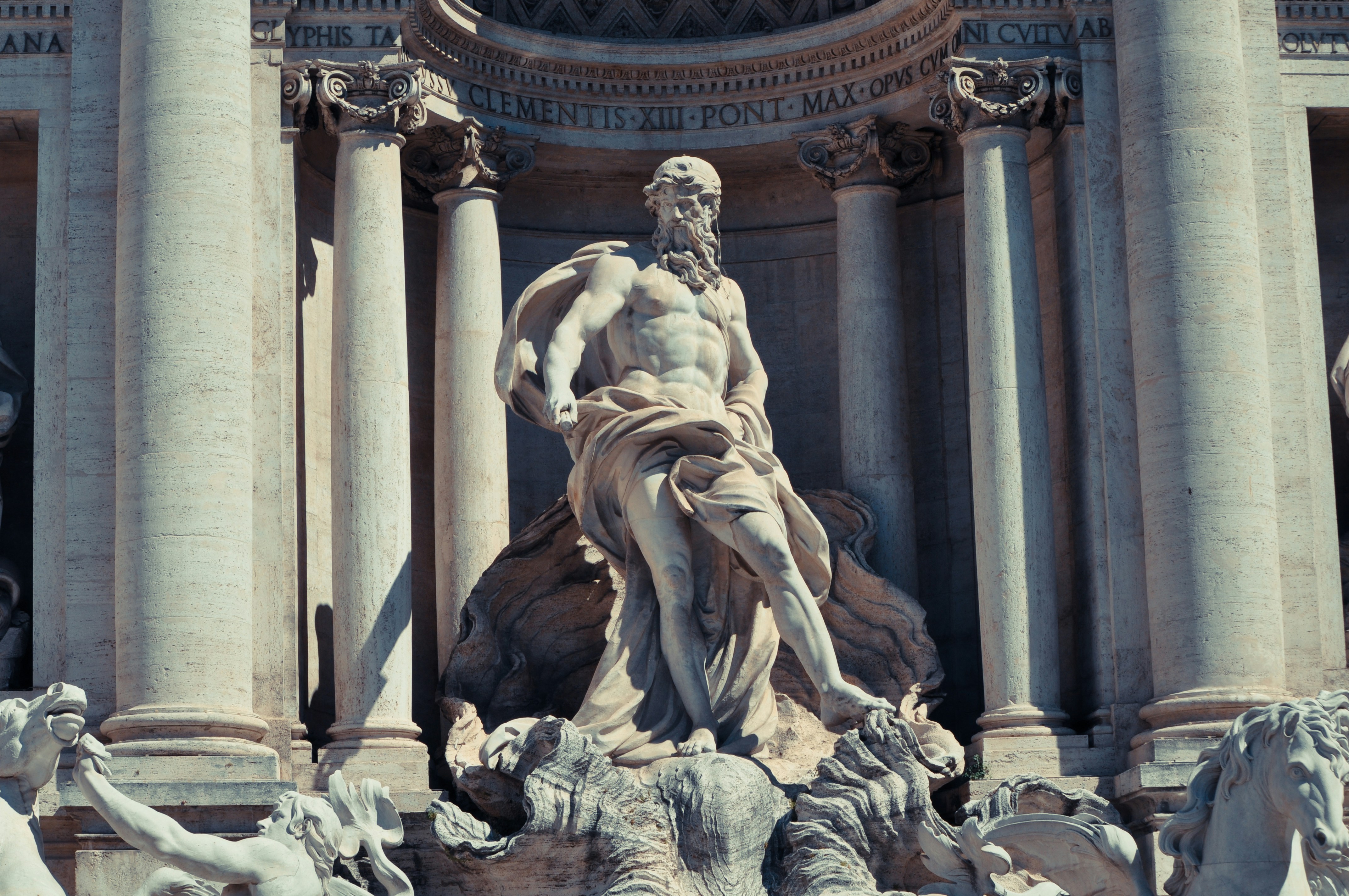Central Titan: Classical sculpture crowned by towering columns