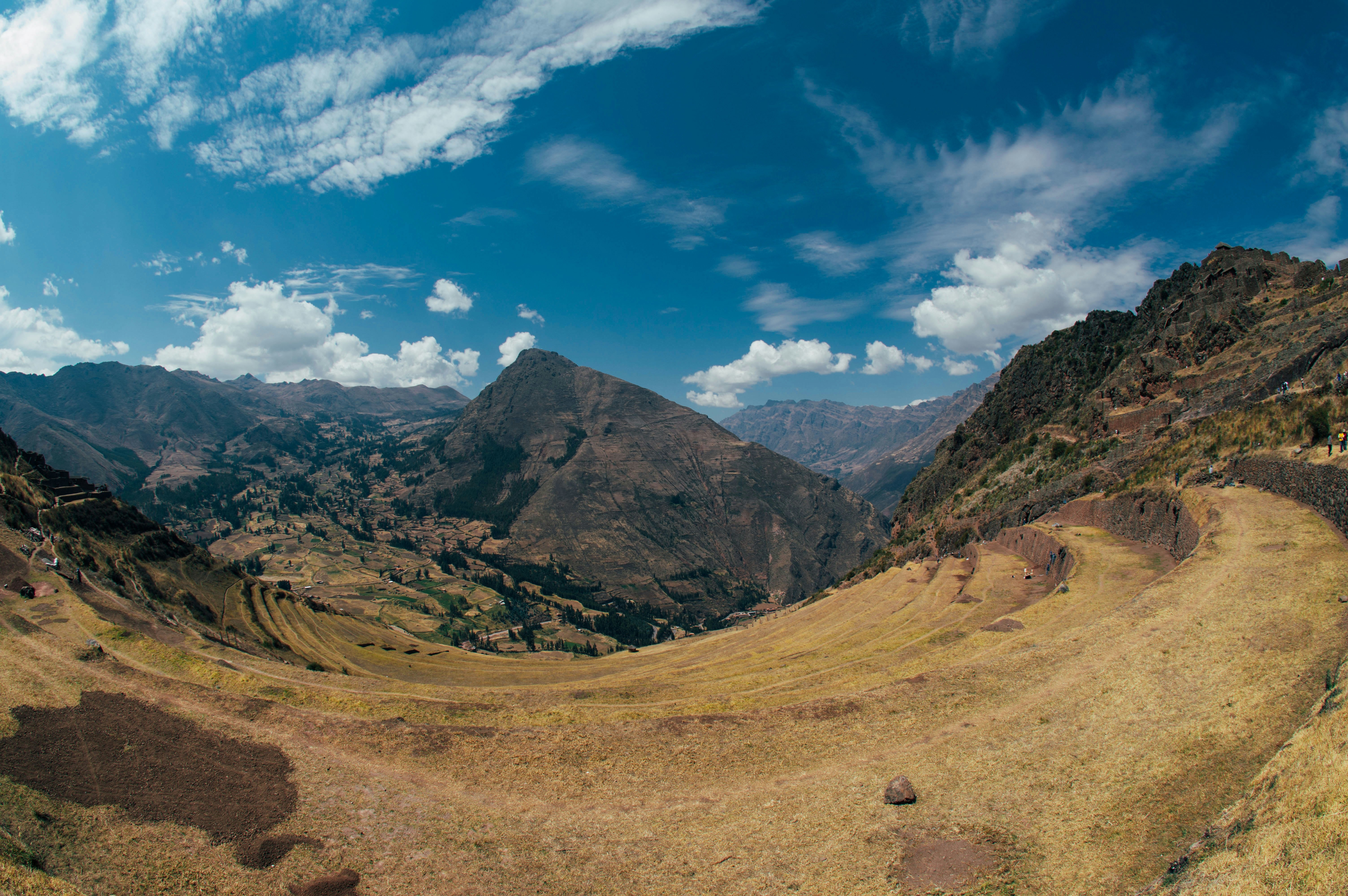 Sunlit amphitheater: terraced valley under a sculpted sky