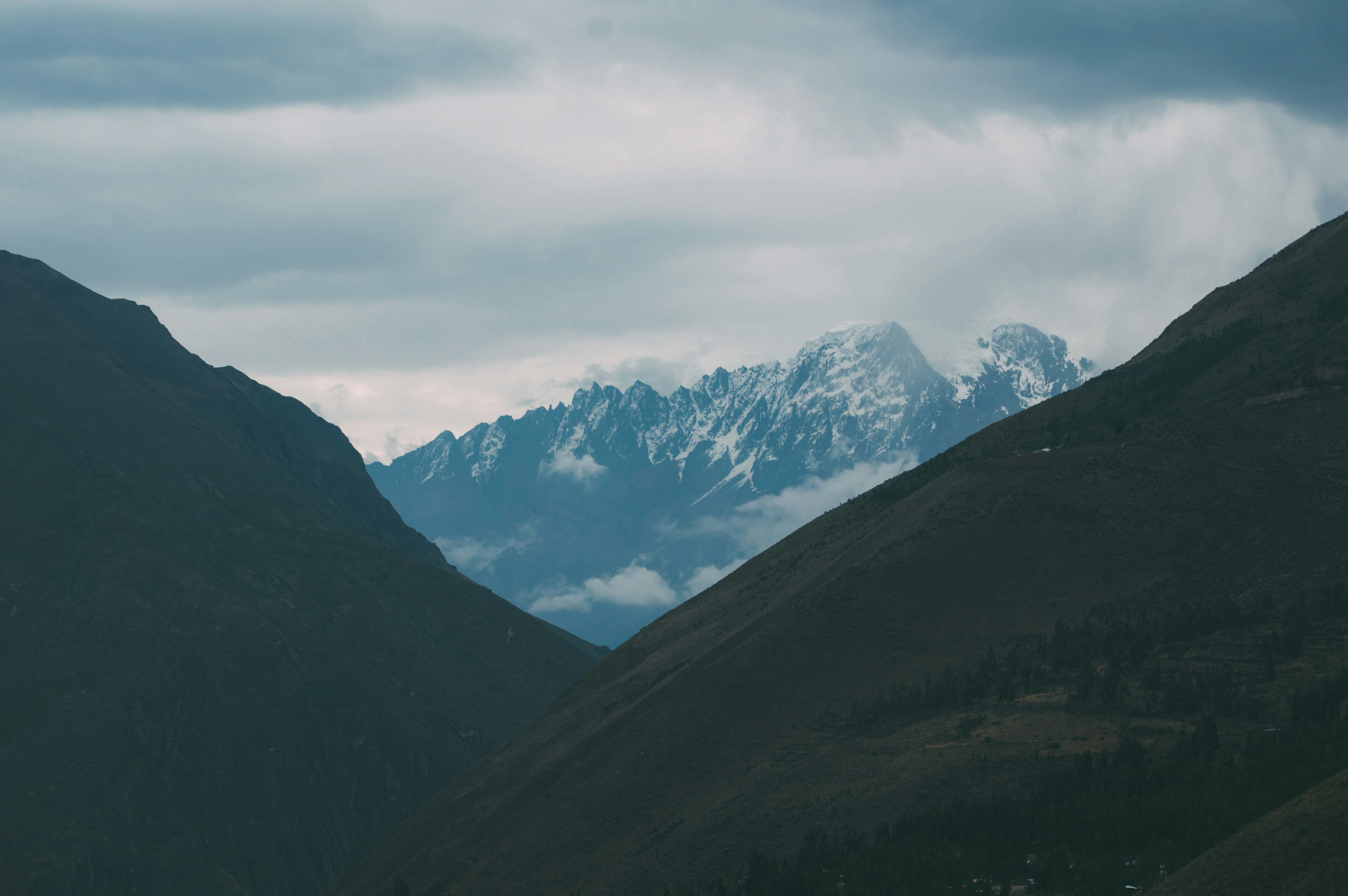 Snow Crowned Peaks Between Shadowed Slopes