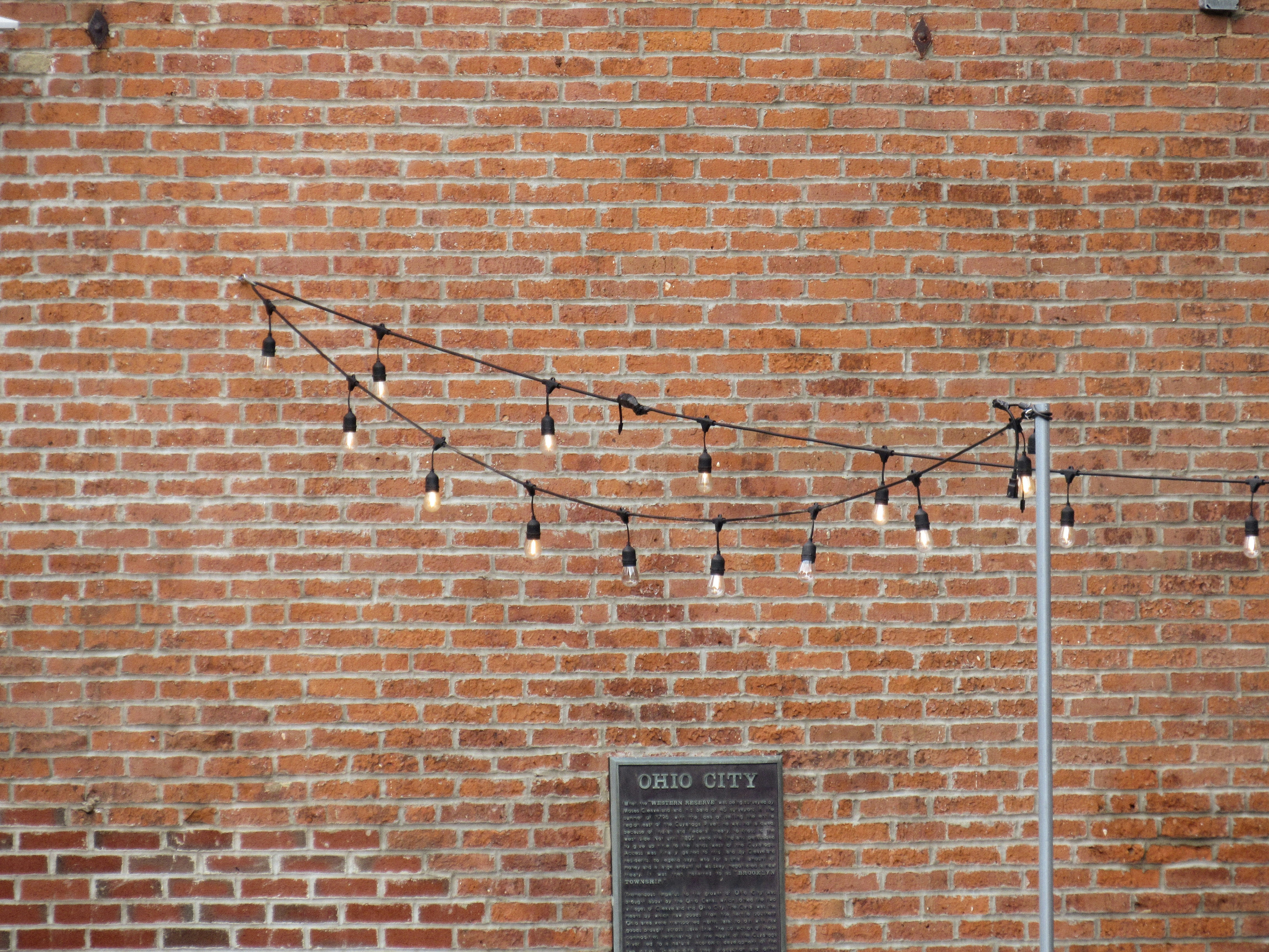 String of Glow: A Row of Bistro Lights Against a Brick Wall
