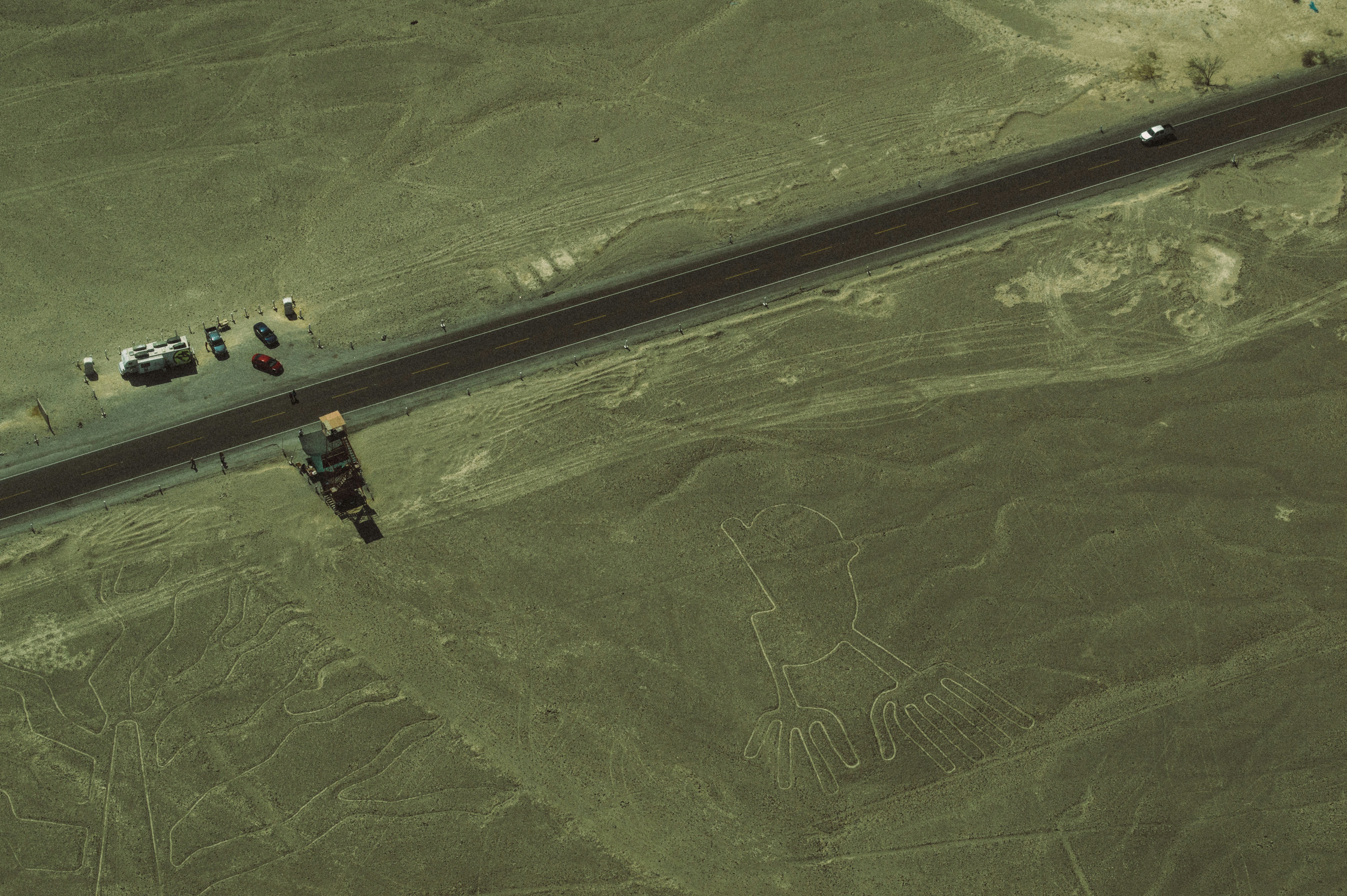 Road Overpass Overlooking a Hidden Glyph of Hands in a Desert Plain