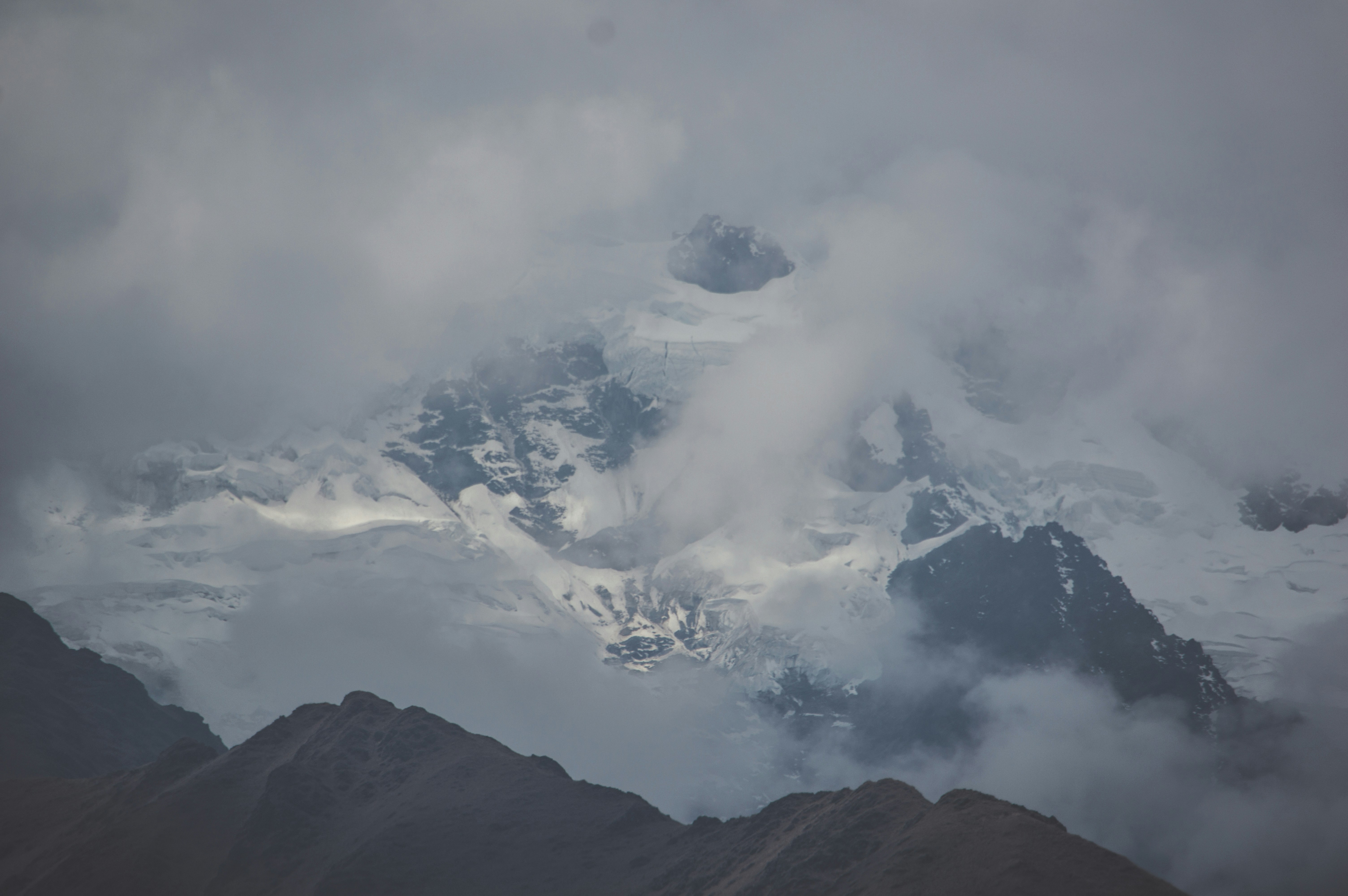Mist-blanketed Ridge: A Peak Peeking Through the Clouds