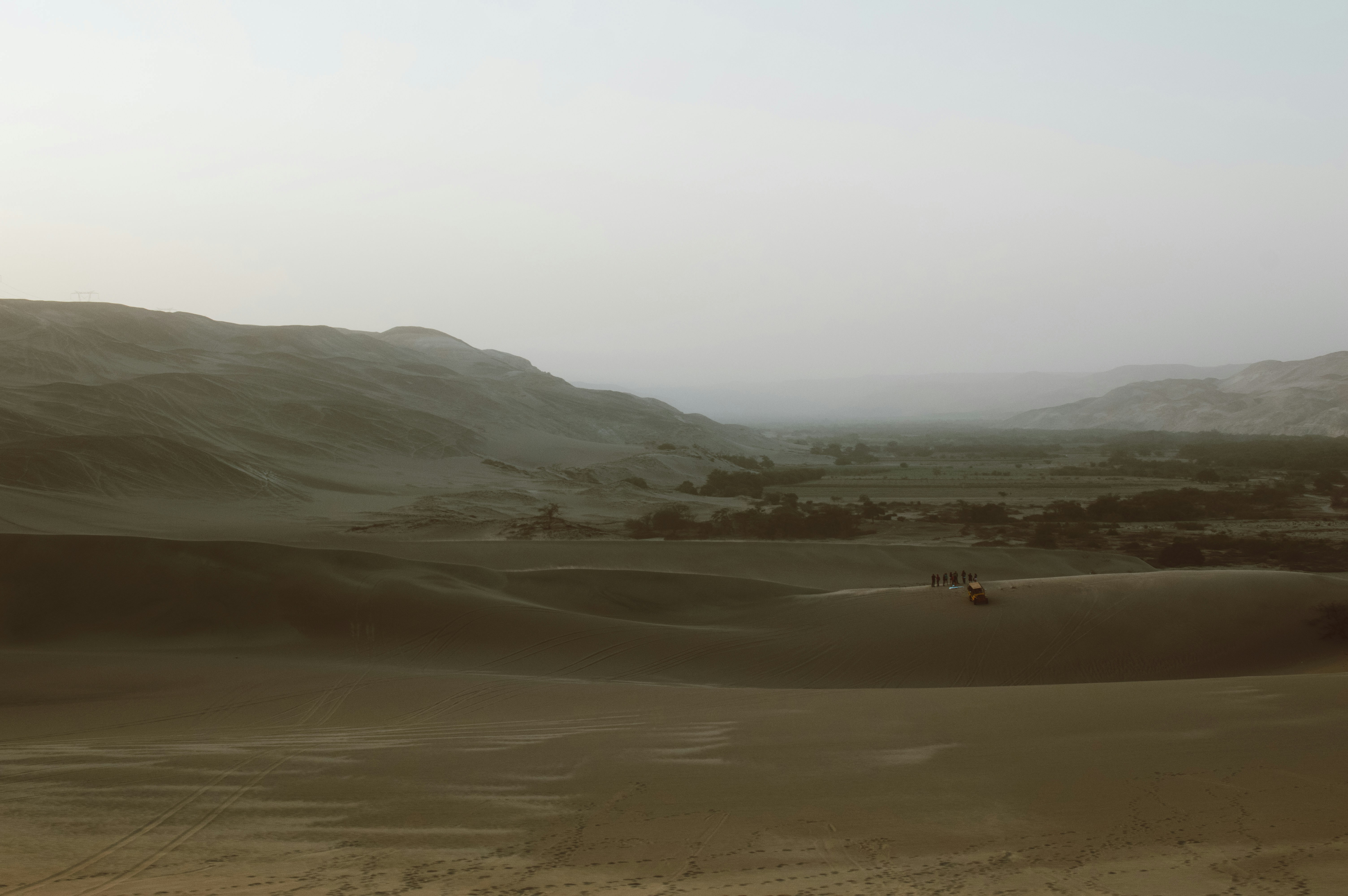 Desert Quiet: Wind-Carved Dunes and Distant Silhouette