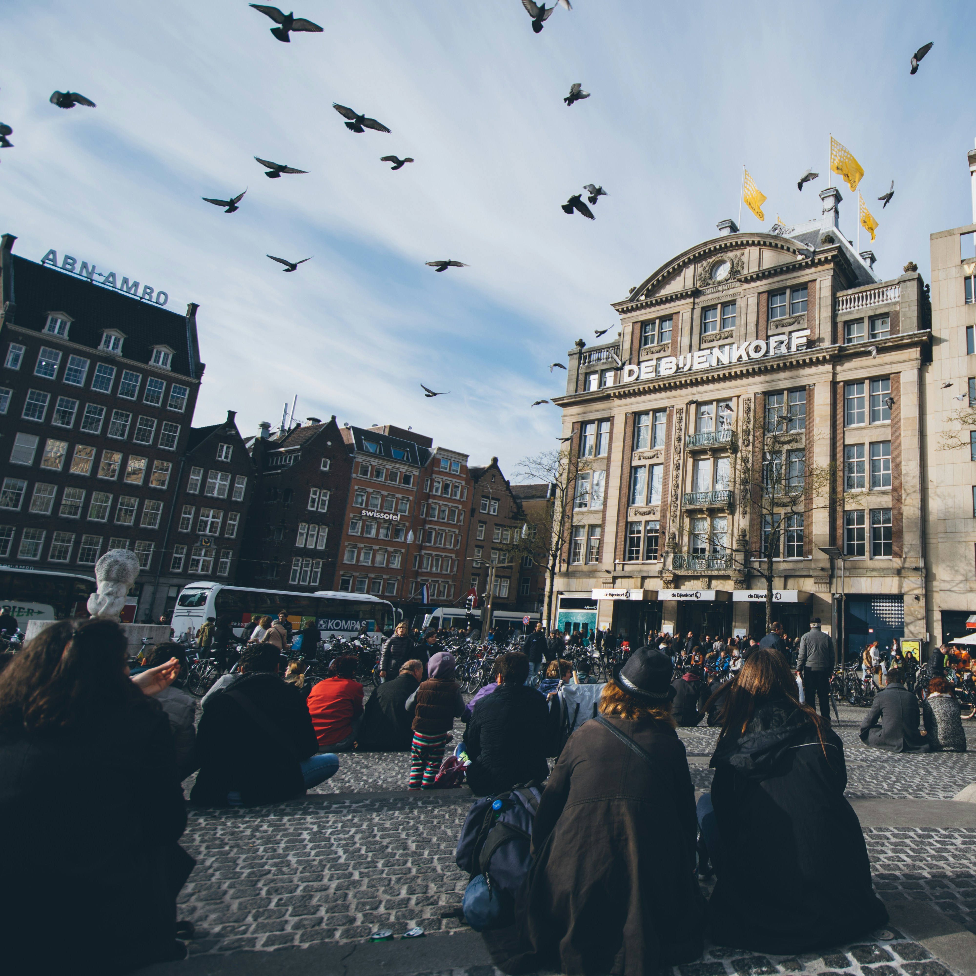 Crowd Scene at Amsterdam Central Station Plaza with Flying Vistors
