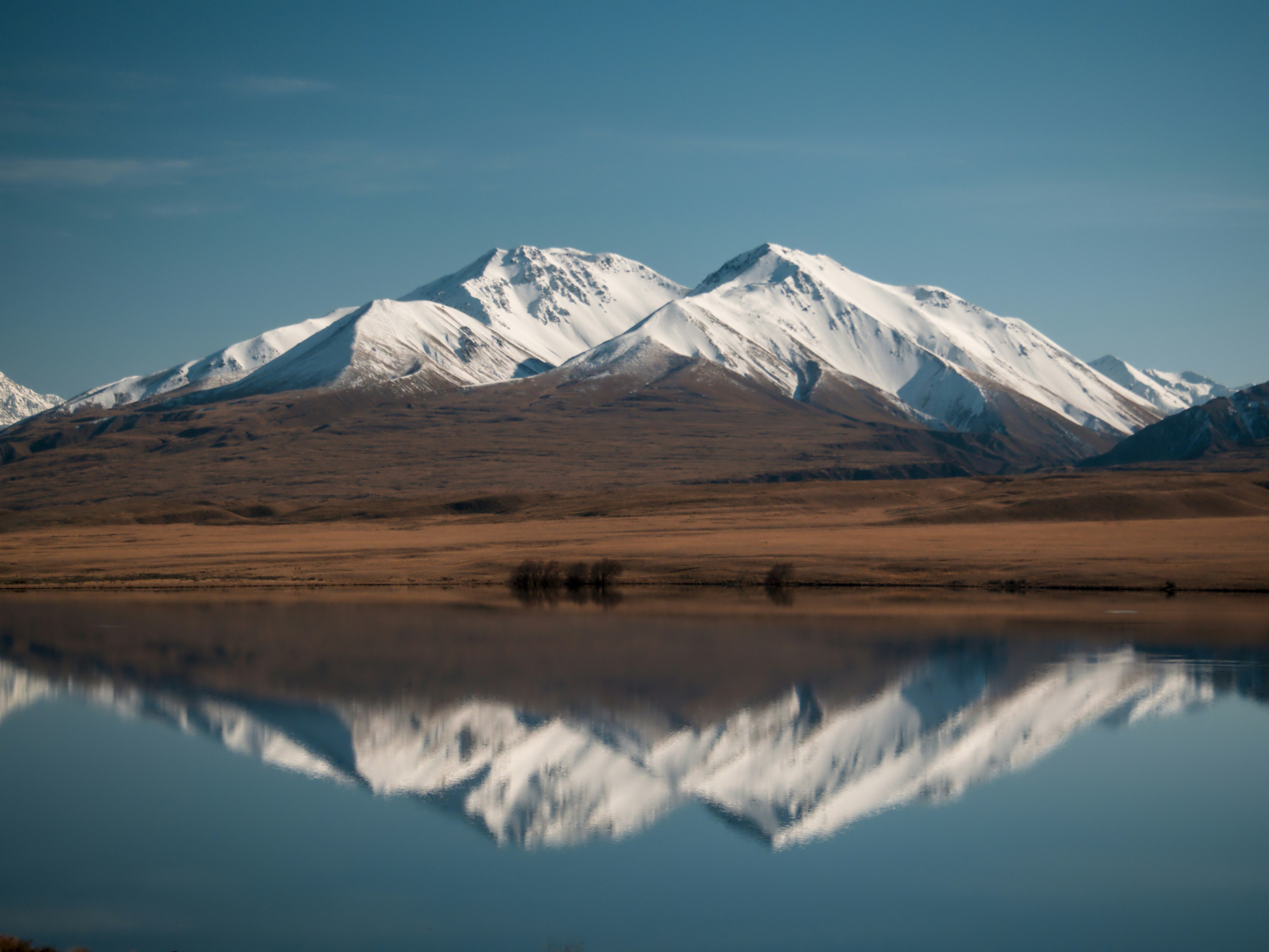 Mirror Peaks: Snow-Capped Giants Over a Glassy Basin