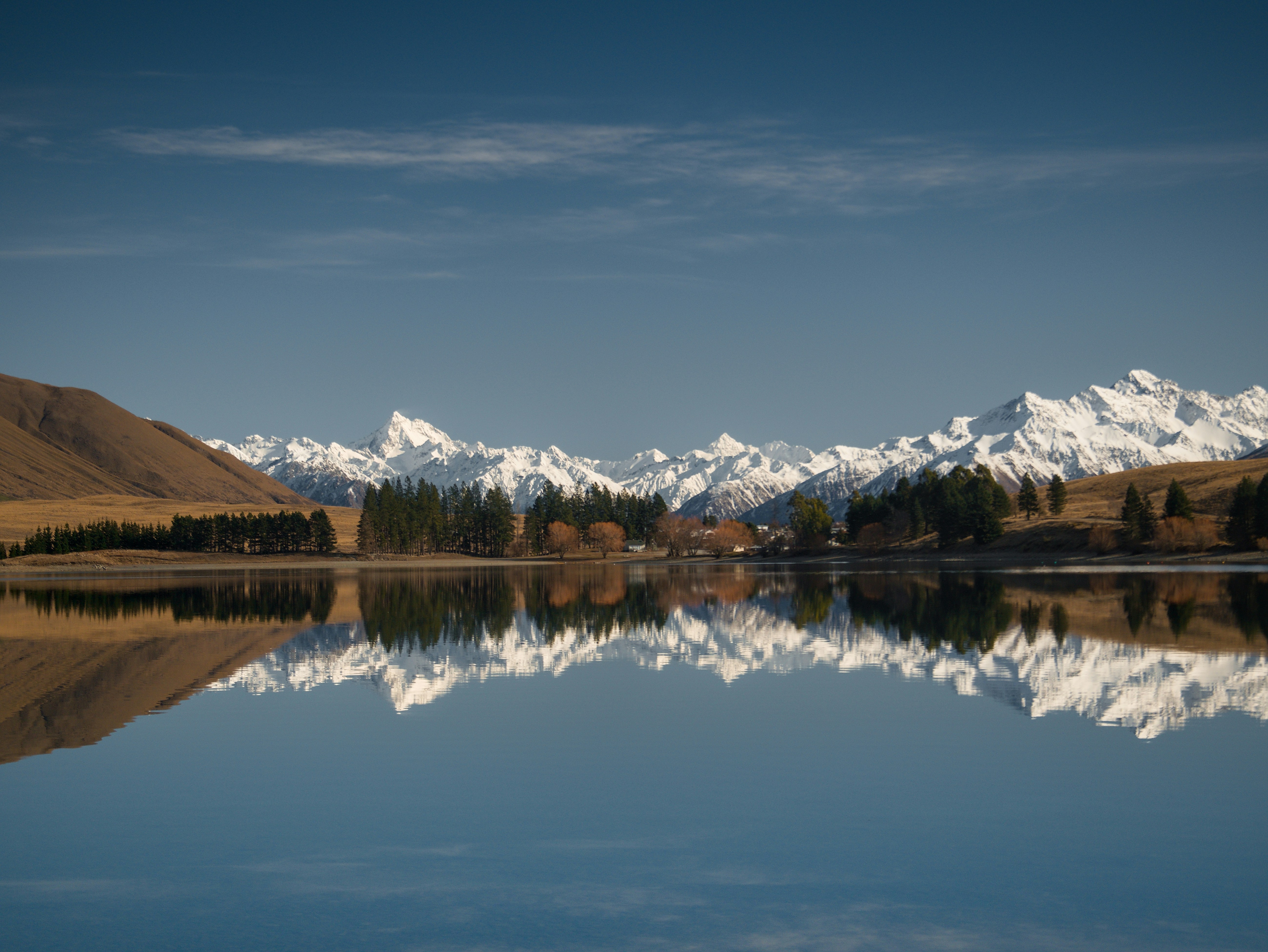 Mirror Ridge: Snow-Capped Peaks Reflected in Glassy Lake