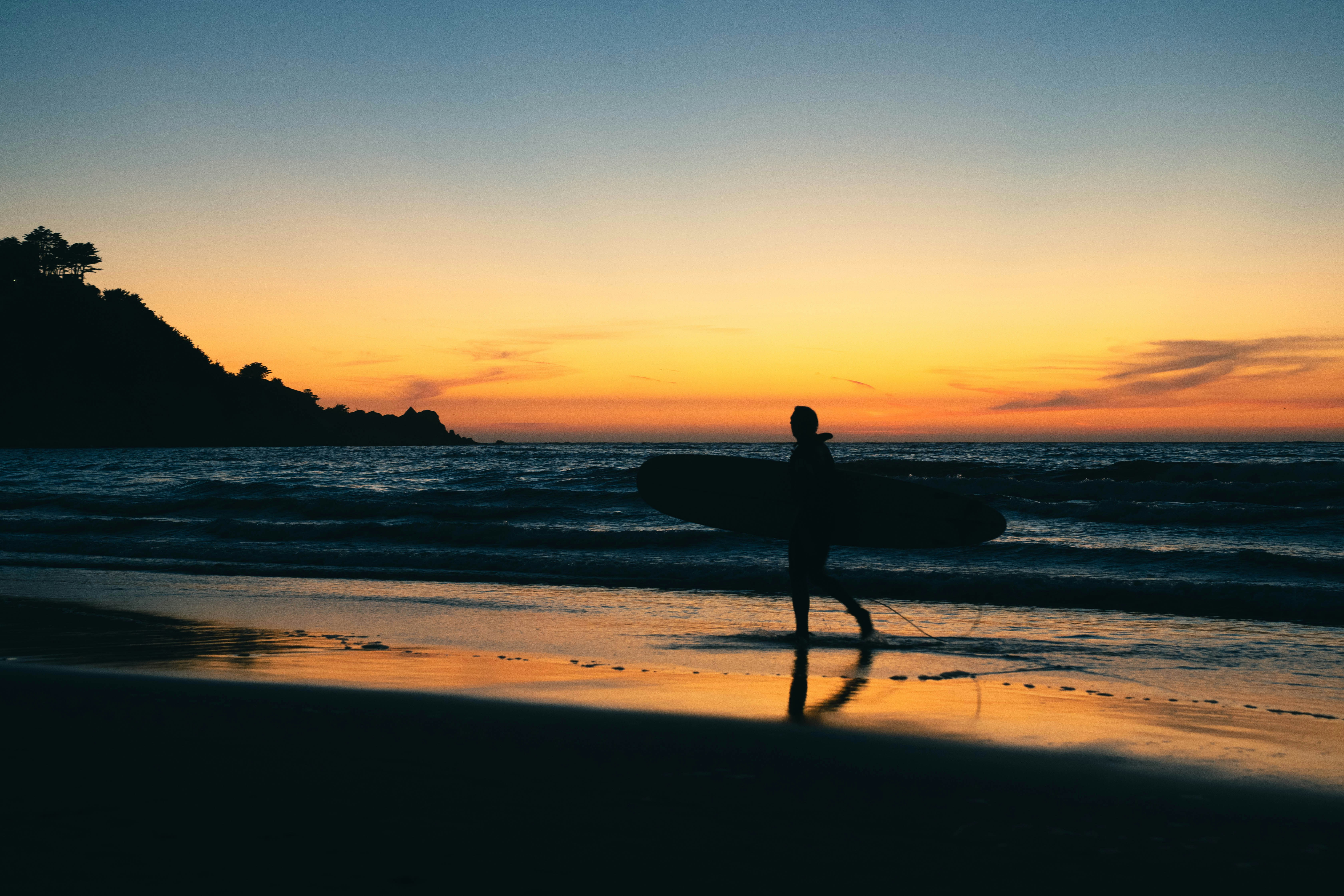 Silhouette Surfer at Dusk: A Quiet Moment by the Ocean Rim