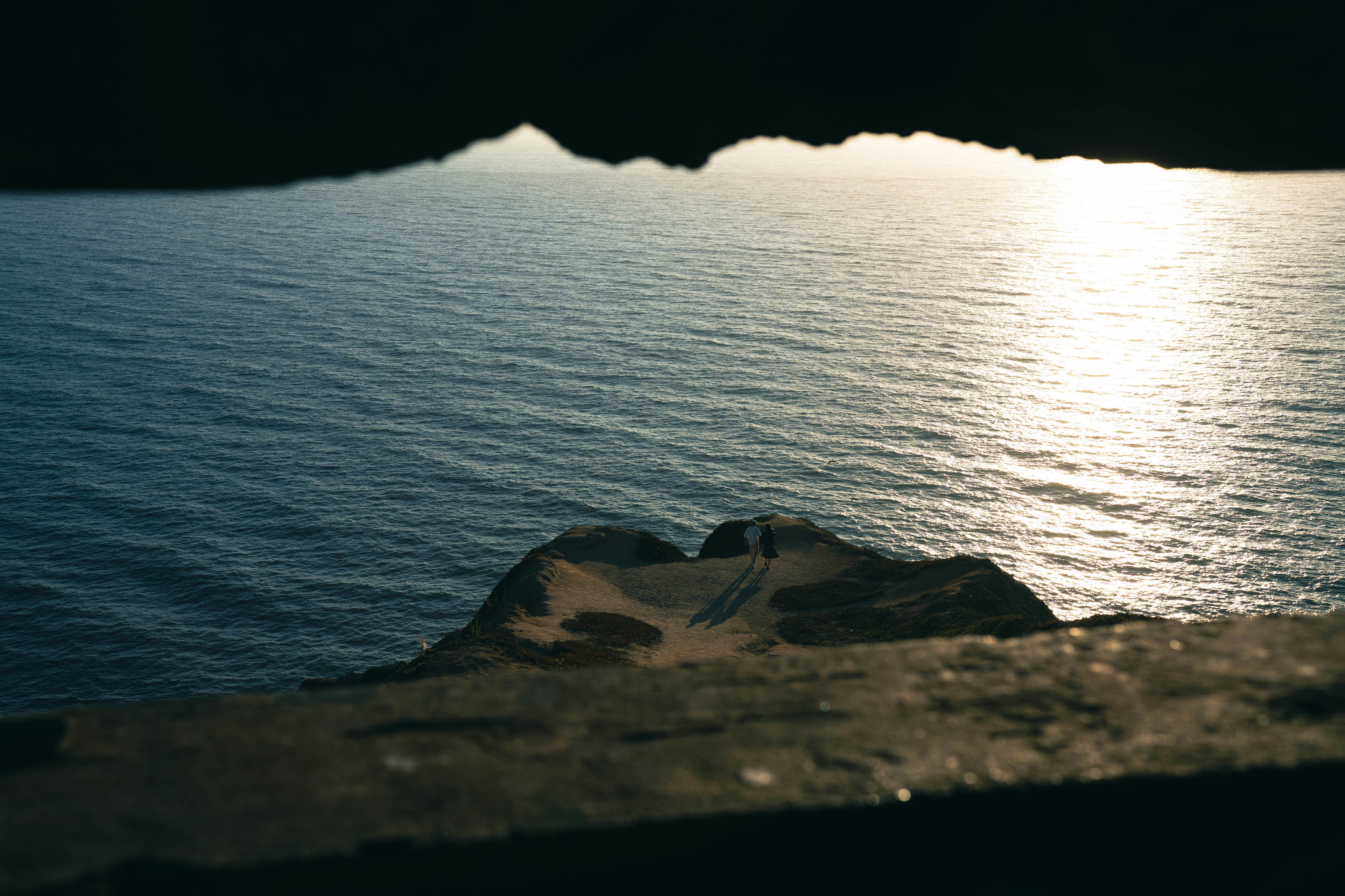 Opposing Horizons: Cliff Edge Over Quiet Seas at Sunset
