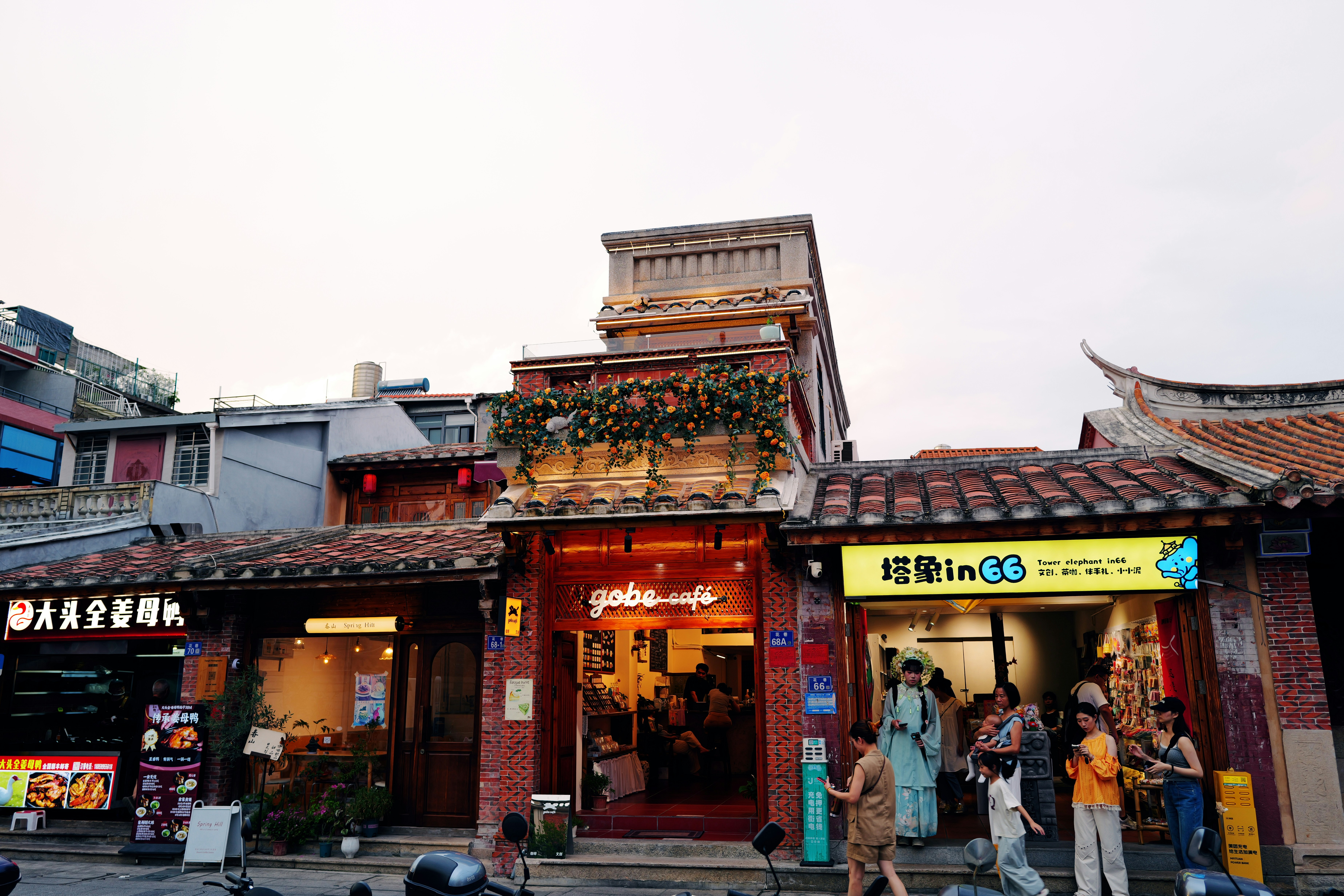 Street-front Heritage: Lantern-lit Shops and Passersby in a Cozy Row