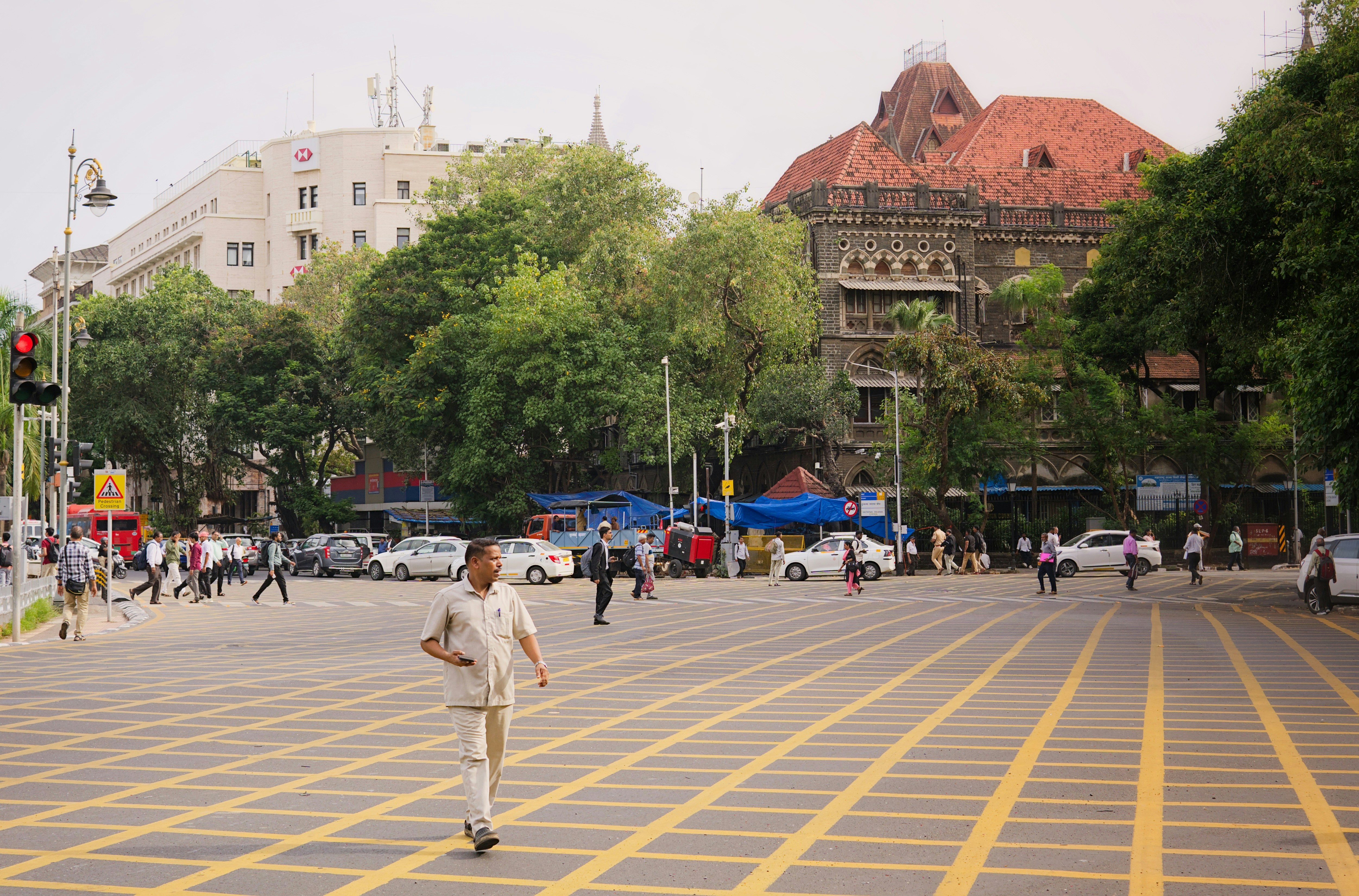 Crosswalk Conductor: A Man in a Light Suit Traverses a Geometric City Grid