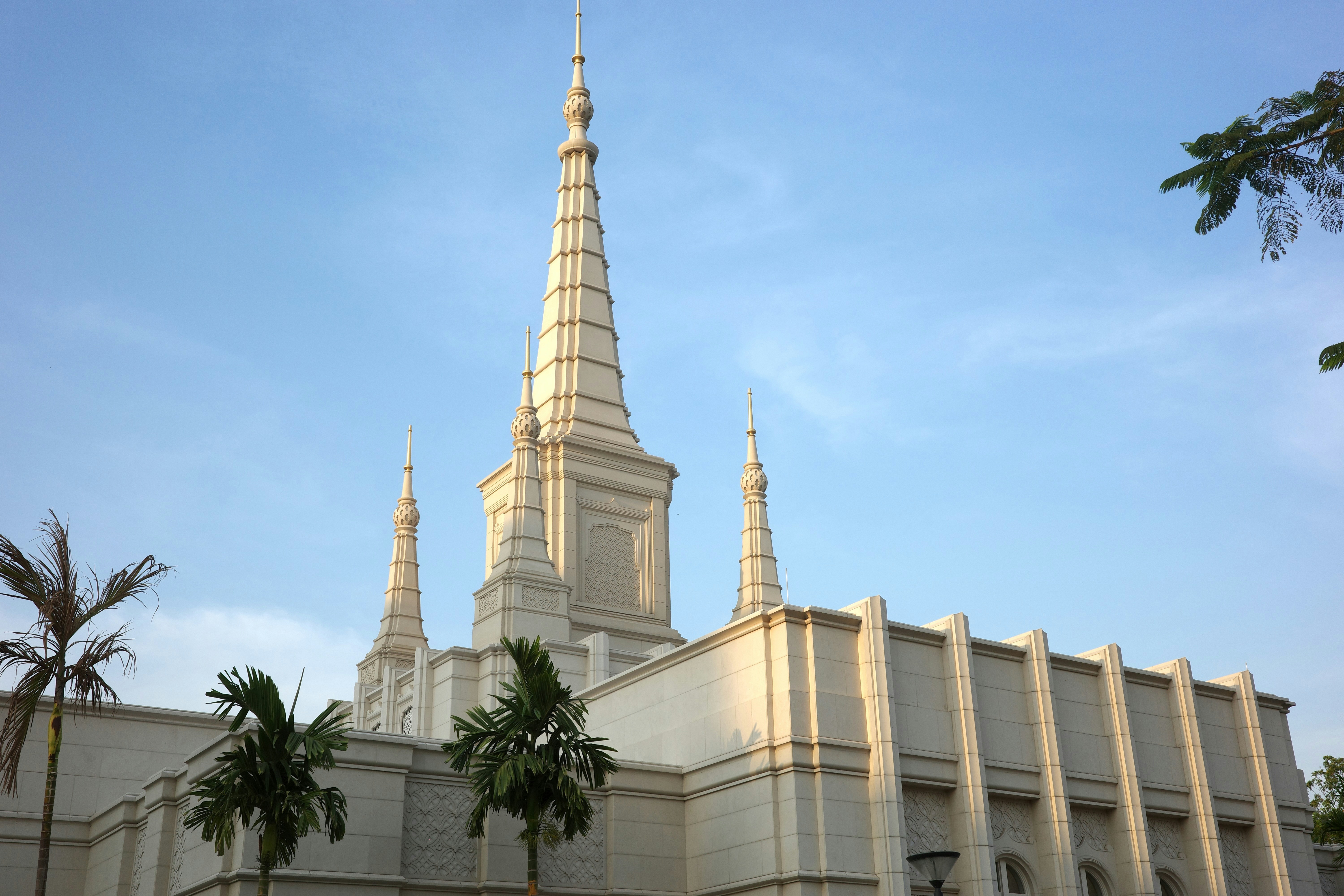 Spire and Sanctuary: White Facade Under a Clear Sky