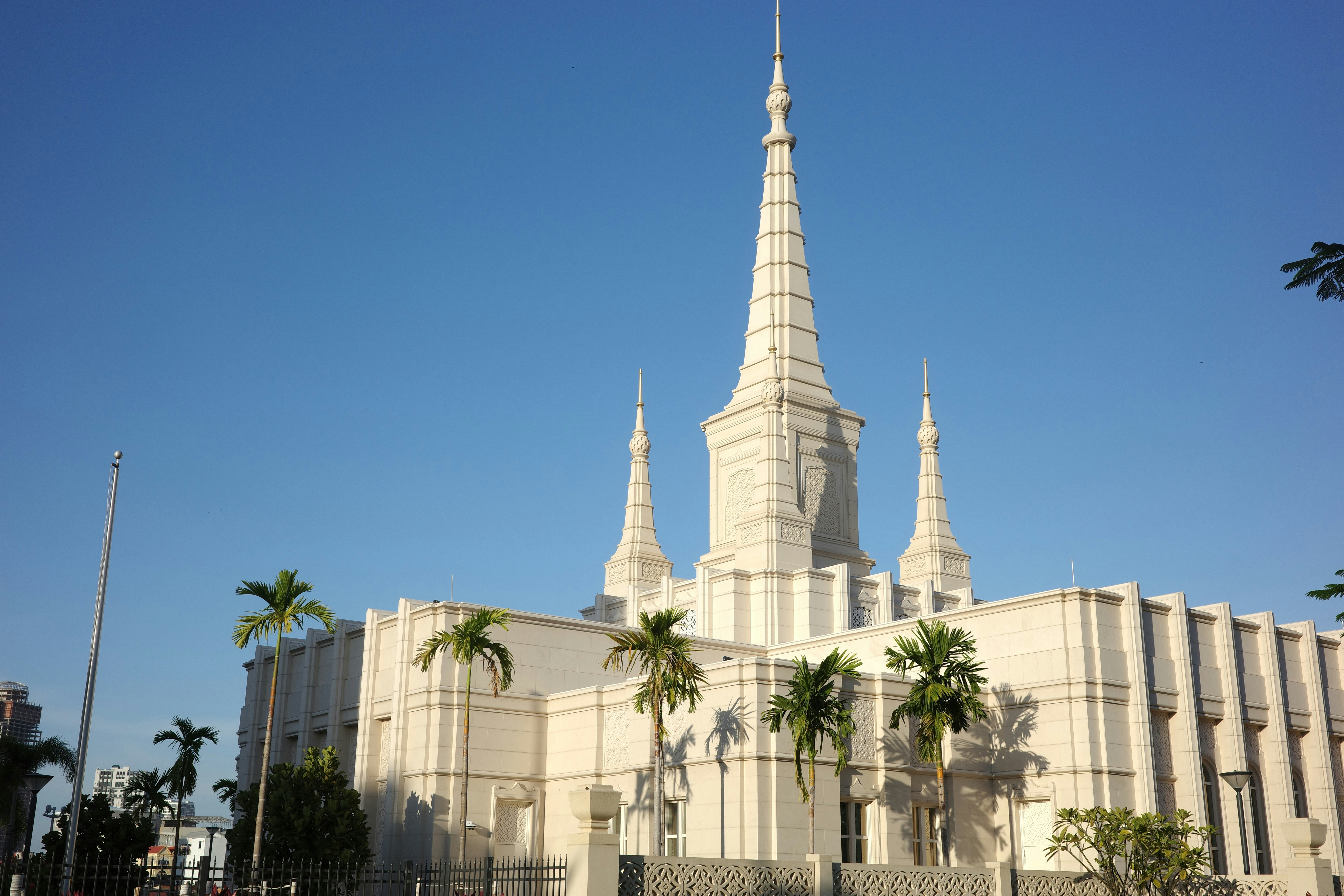 White Spires Against Clear Sky: A Templefront in Palm Shadows