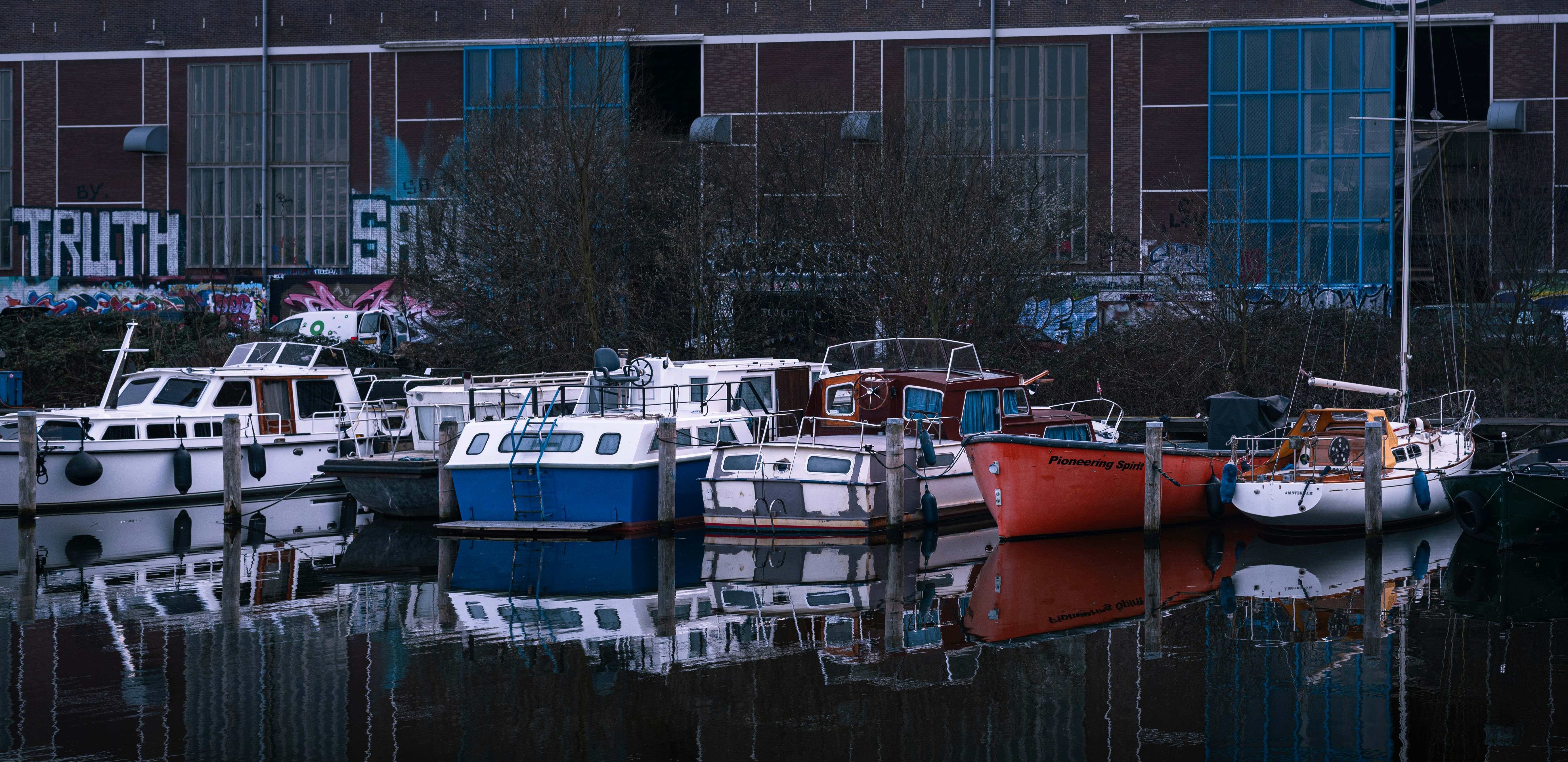 Docked Echoes: Boats, Reflections, and an Urban Warehouse
