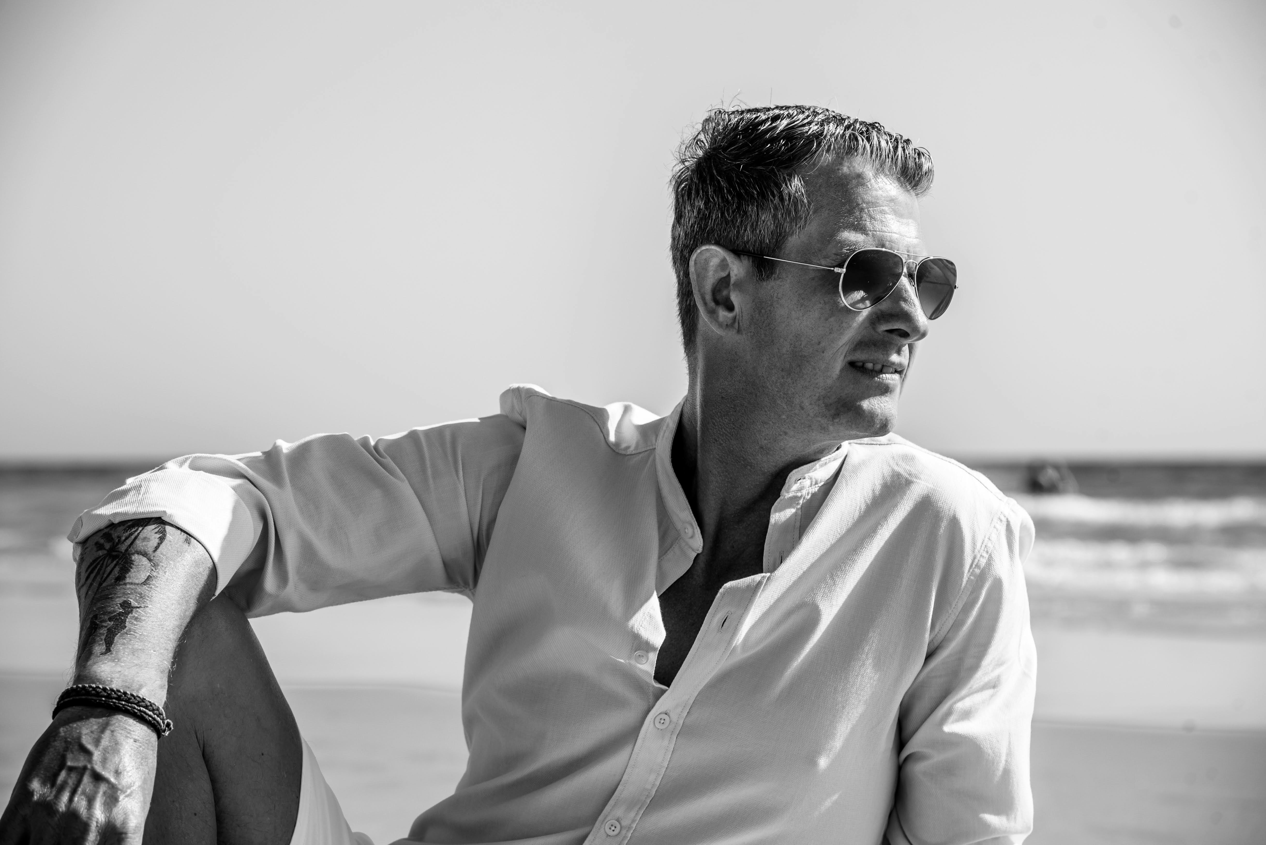 Sunglasses and Sea Breeze: A Portrait on the Shore